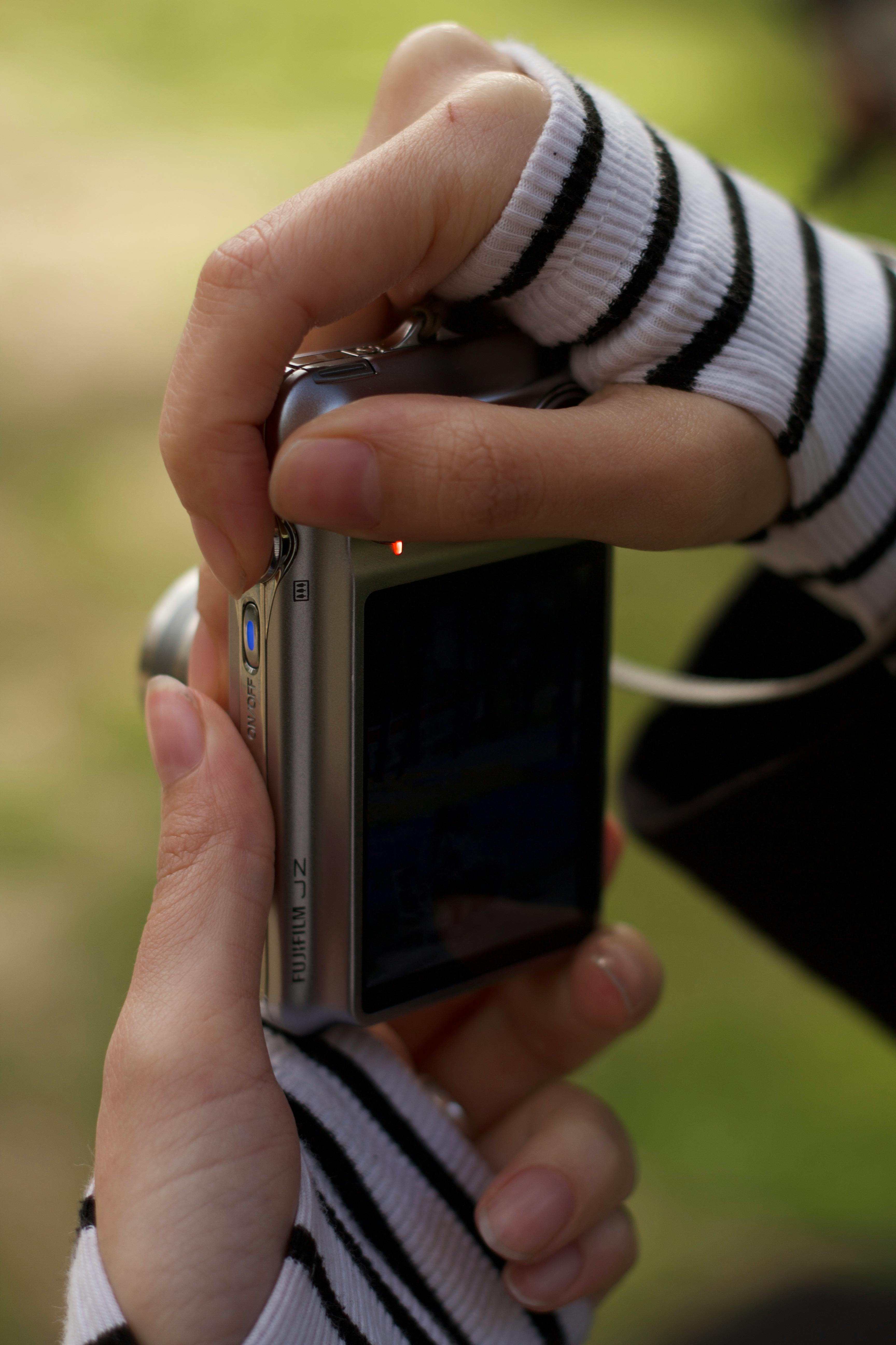 Womans Hands Holding a Camera · Free Stock Photo