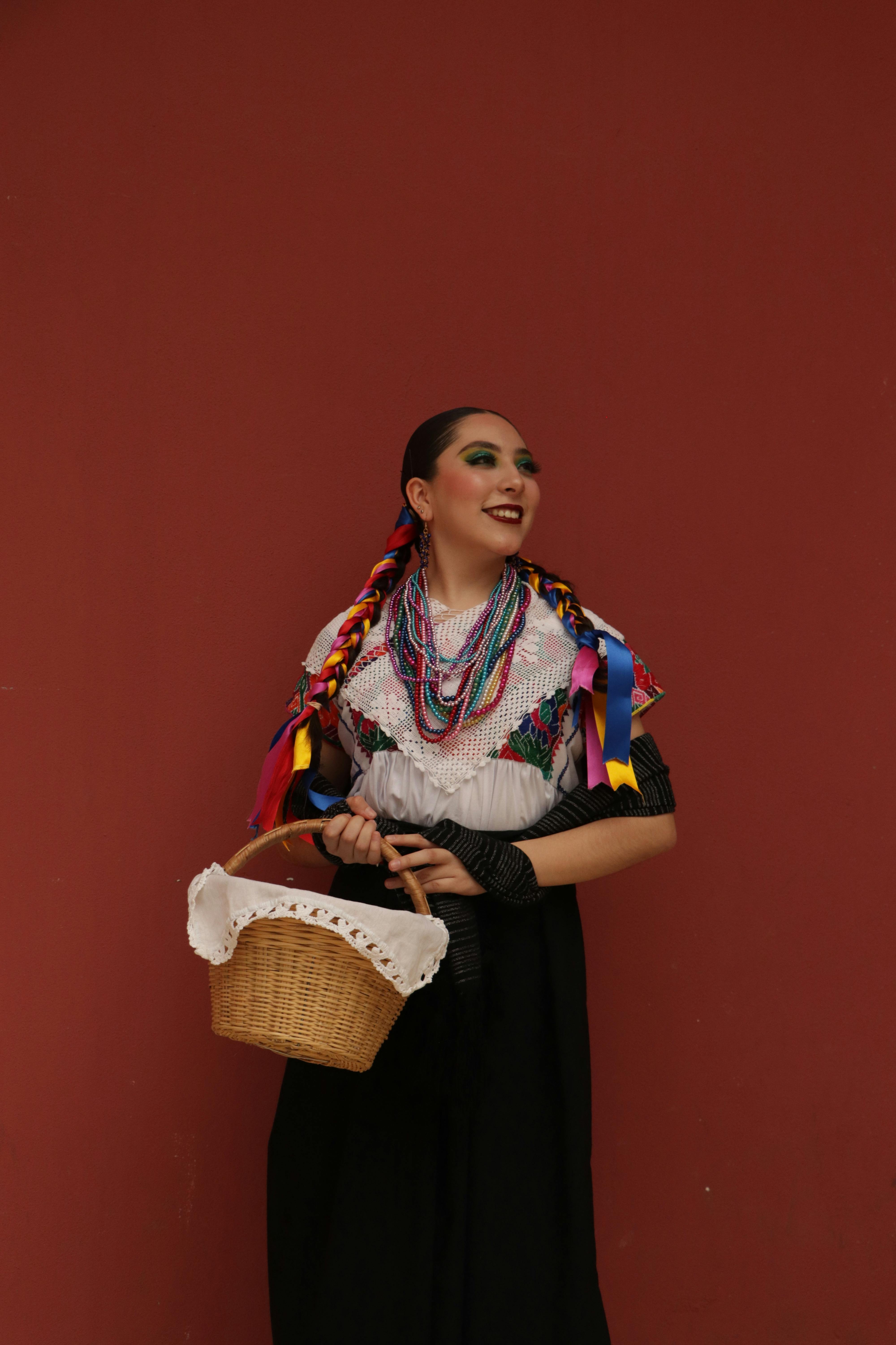 Model in a Folk Costume Posing with a Wicker Basket in Front of a Red ...