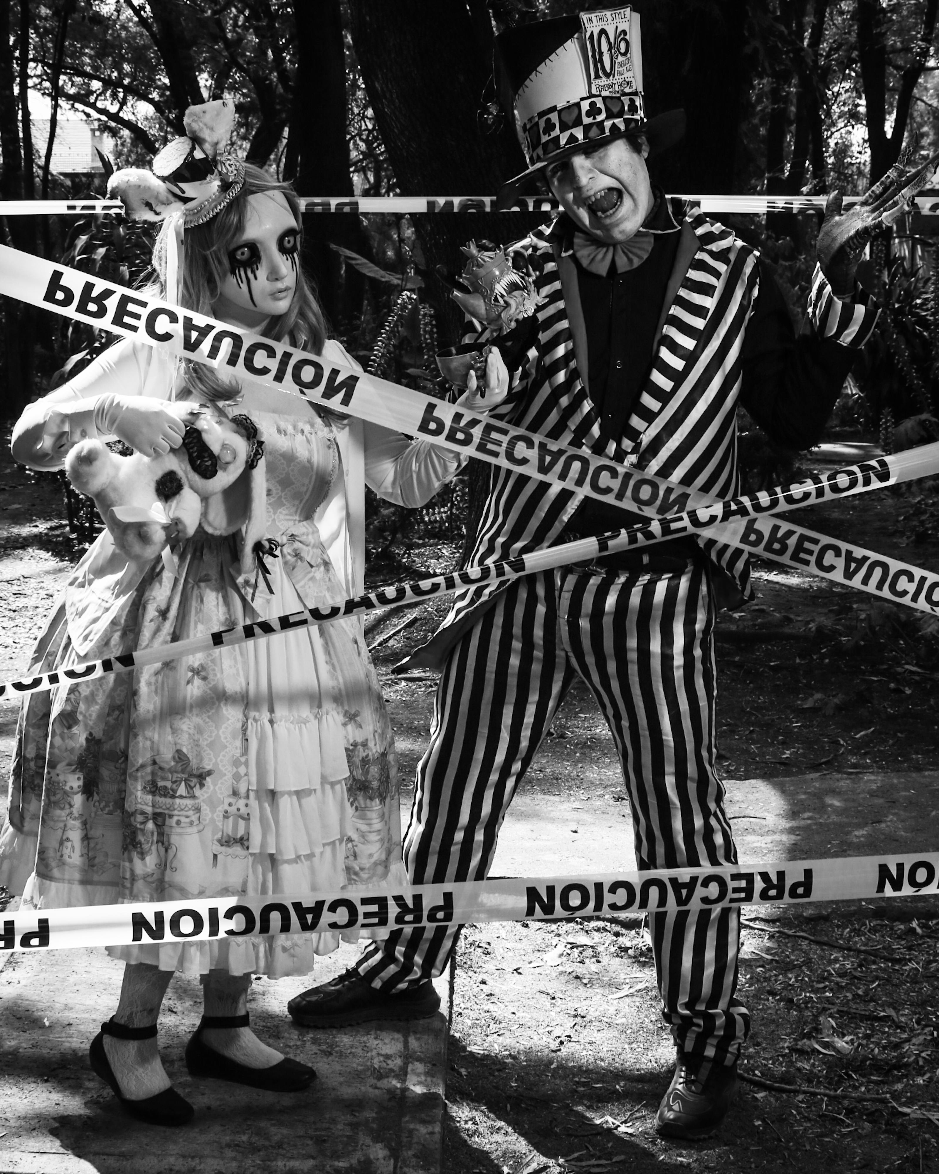 Posing Couple in Halloween Costumes among Crime Scene Straps · Free ...