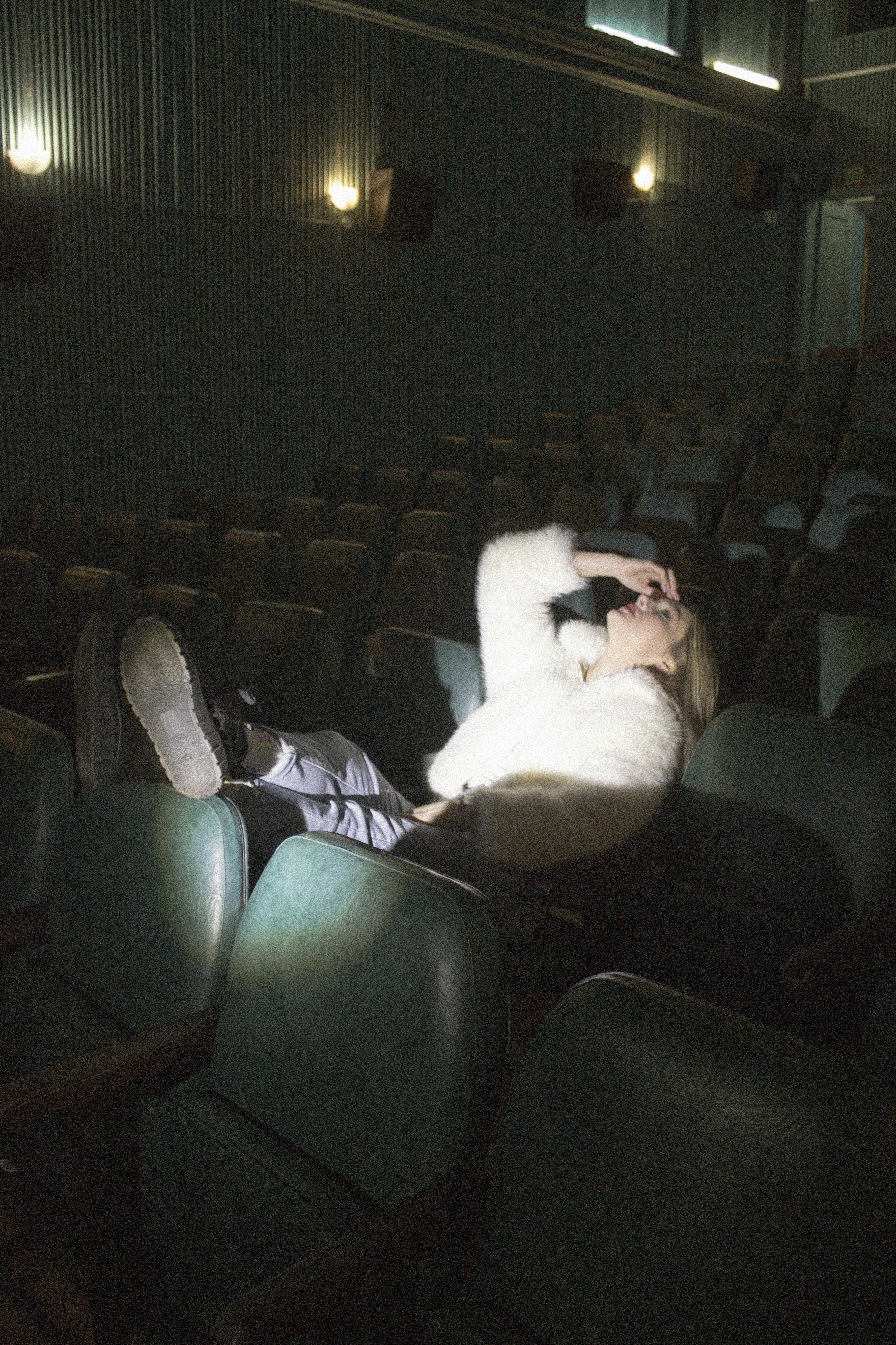 A person laying down in a theater · Free Stock Photo