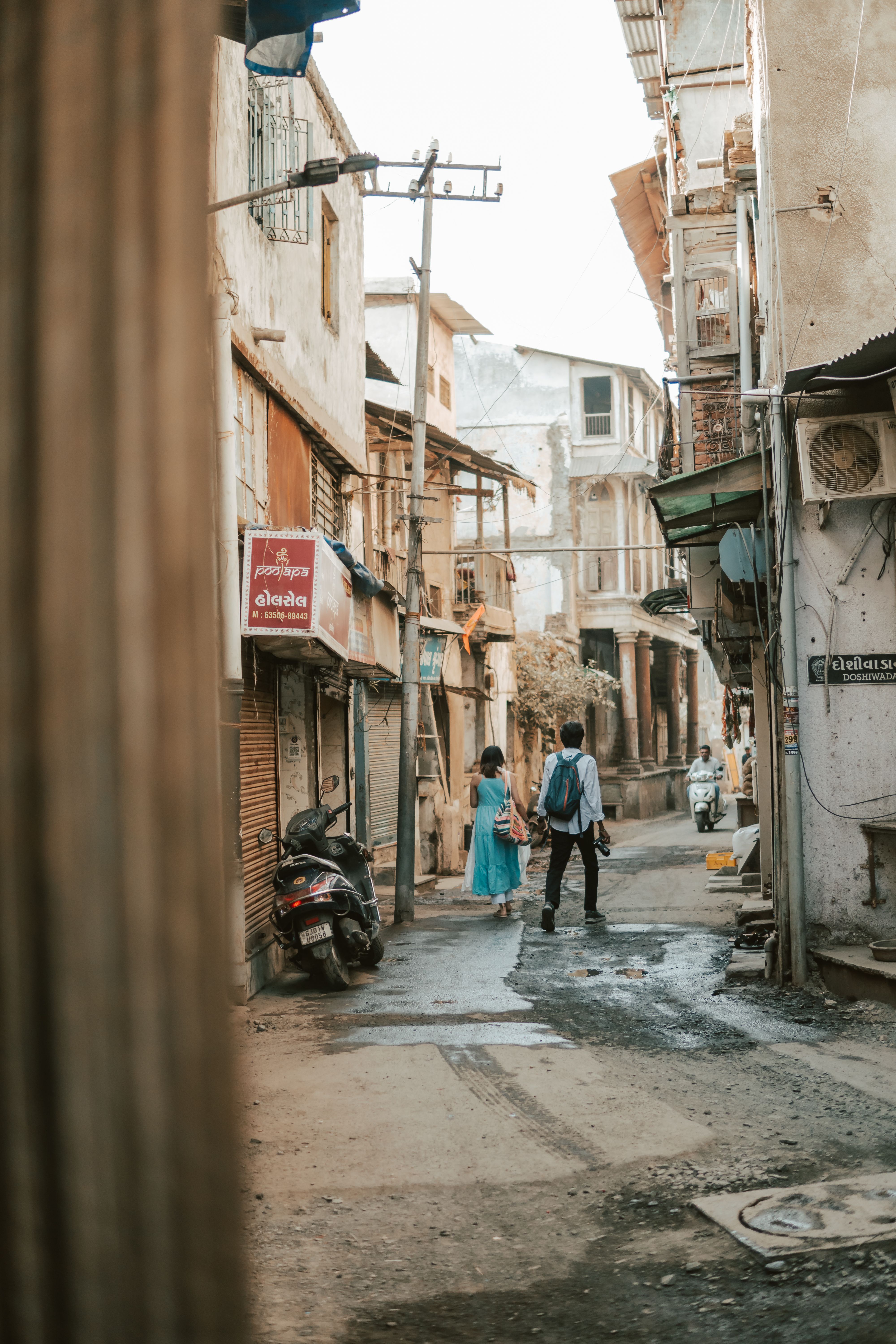 A couple walking down a narrow alley in india · Free Stock Photo