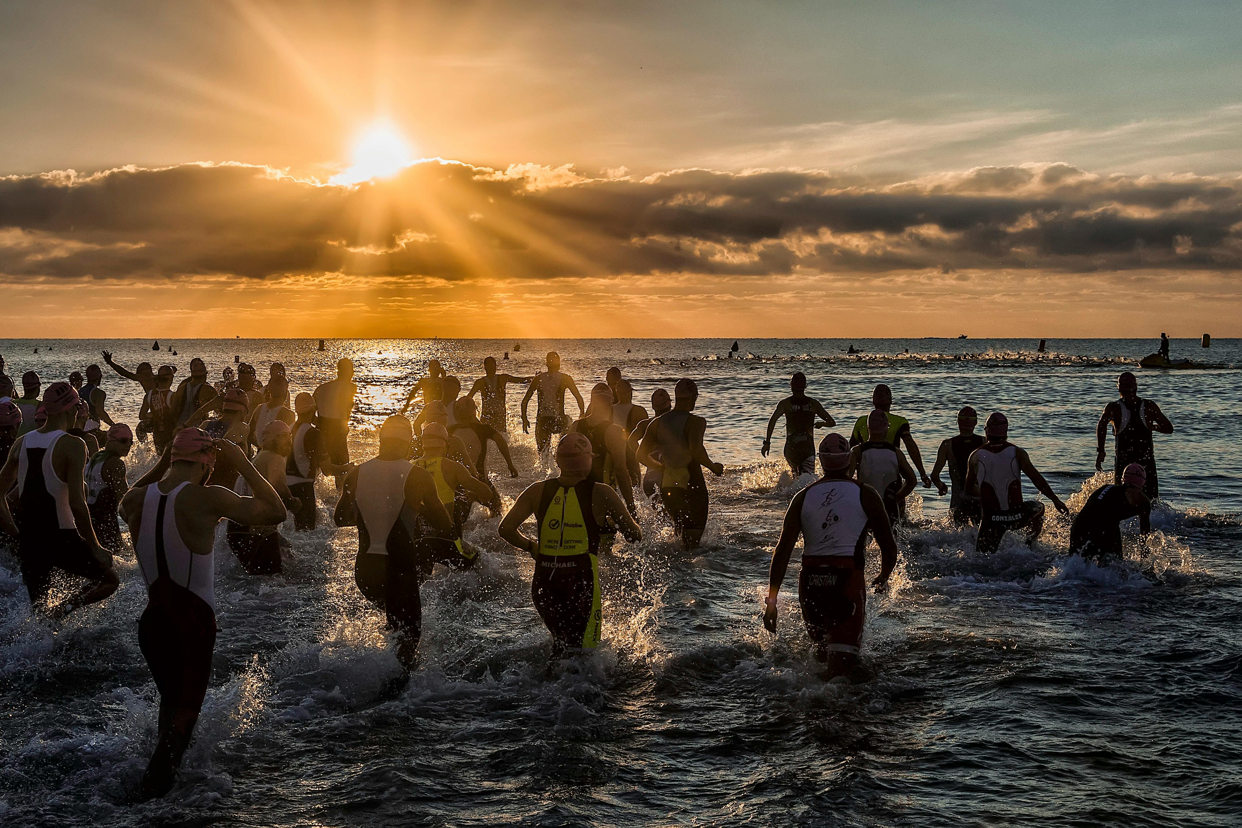 People Bathing in the Sea at Sunrise · Free Stock Photo