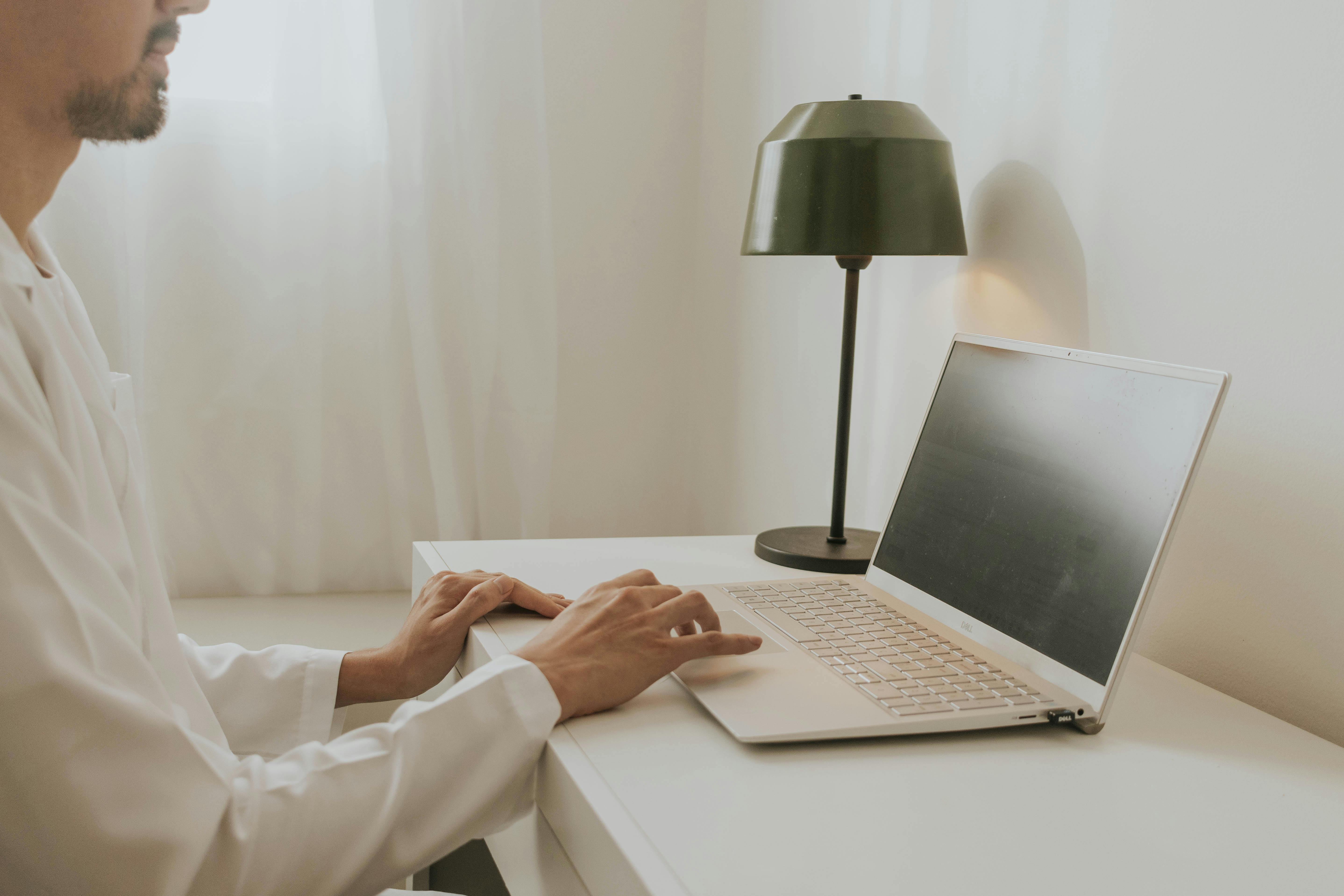Man Sitting by Laptop and Working · Free Stock Photo