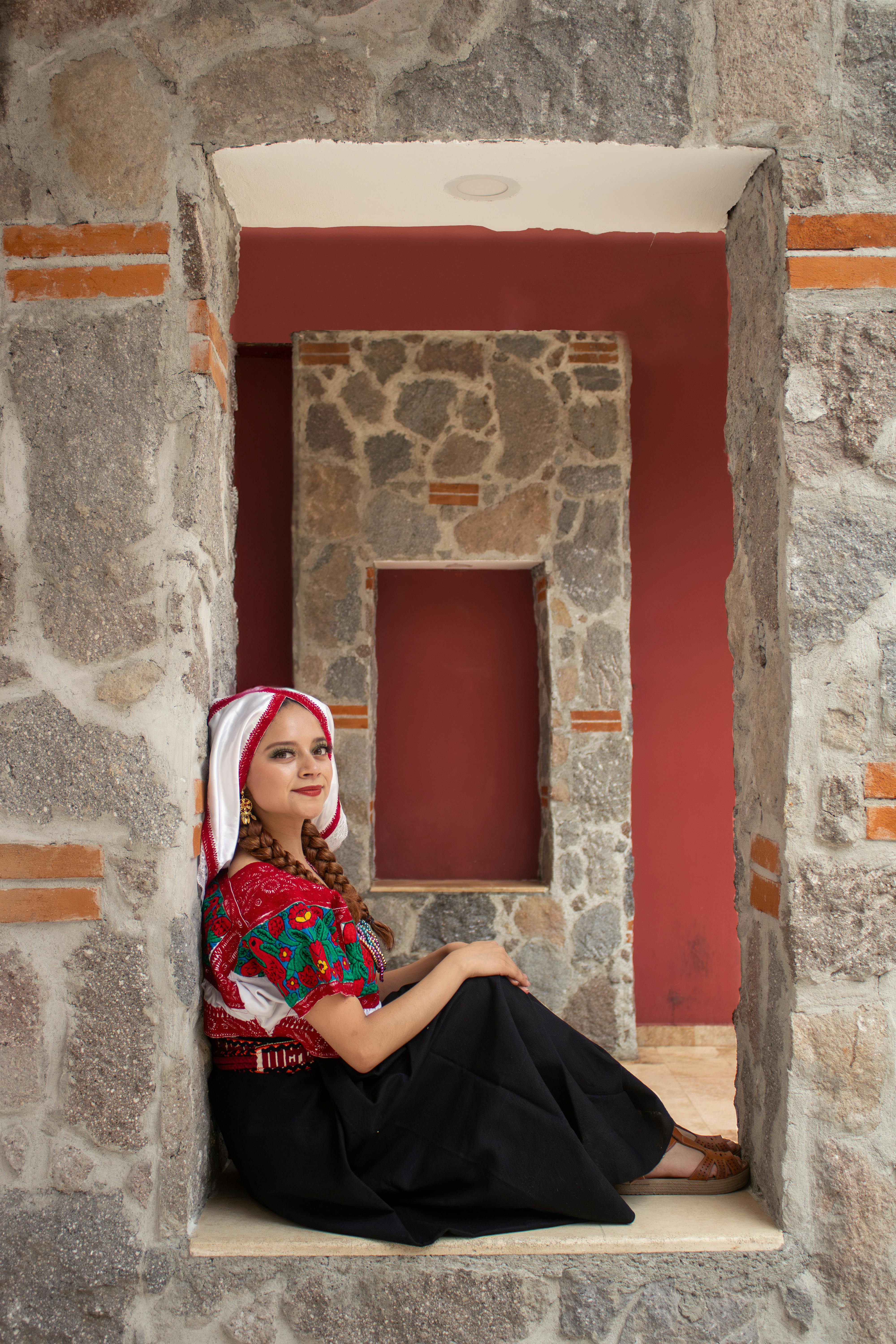 Woman in Rustic Costume Posing in Window · Free Stock Photo