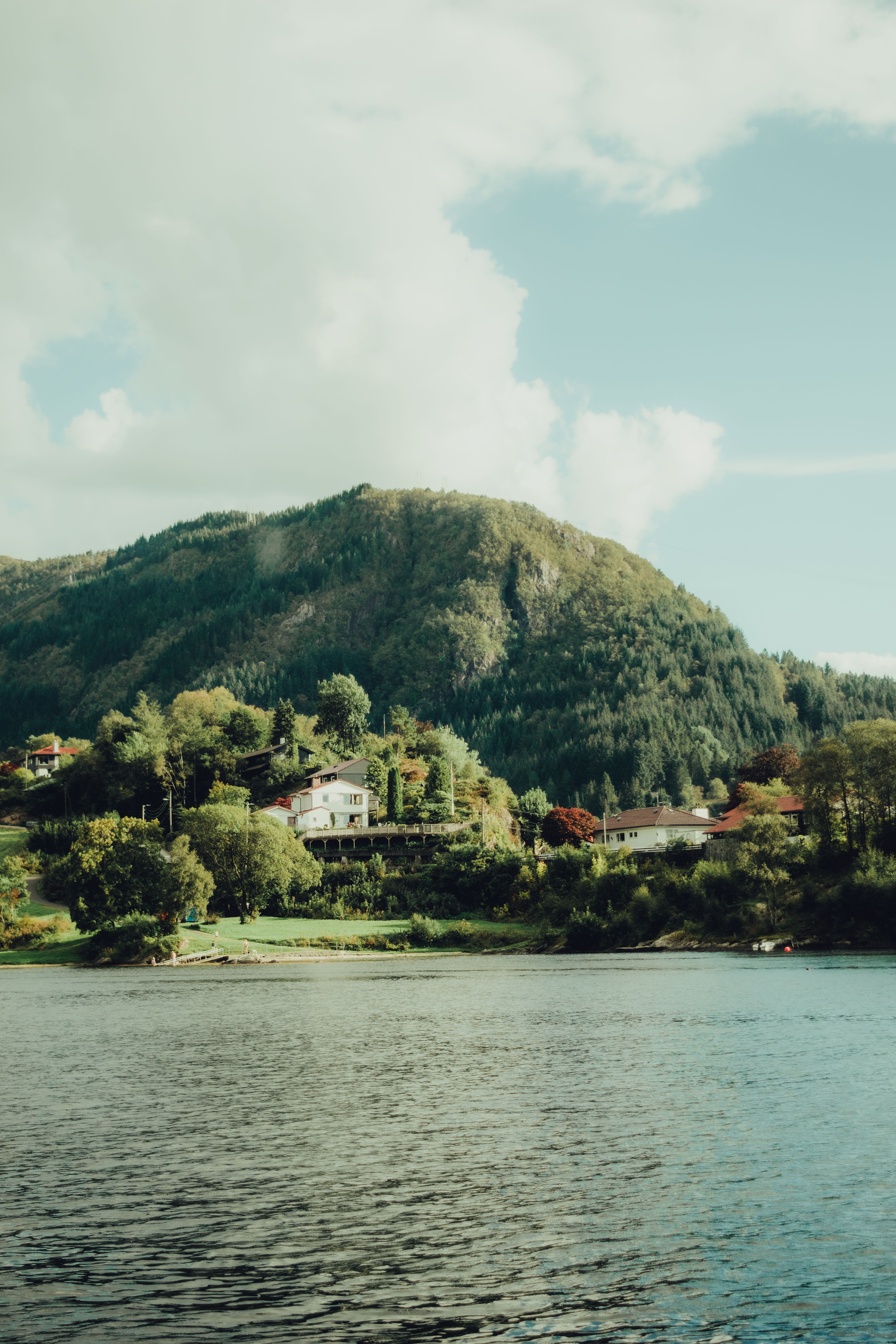 Hill and Village by Lake in Countryside · Free Stock Photo