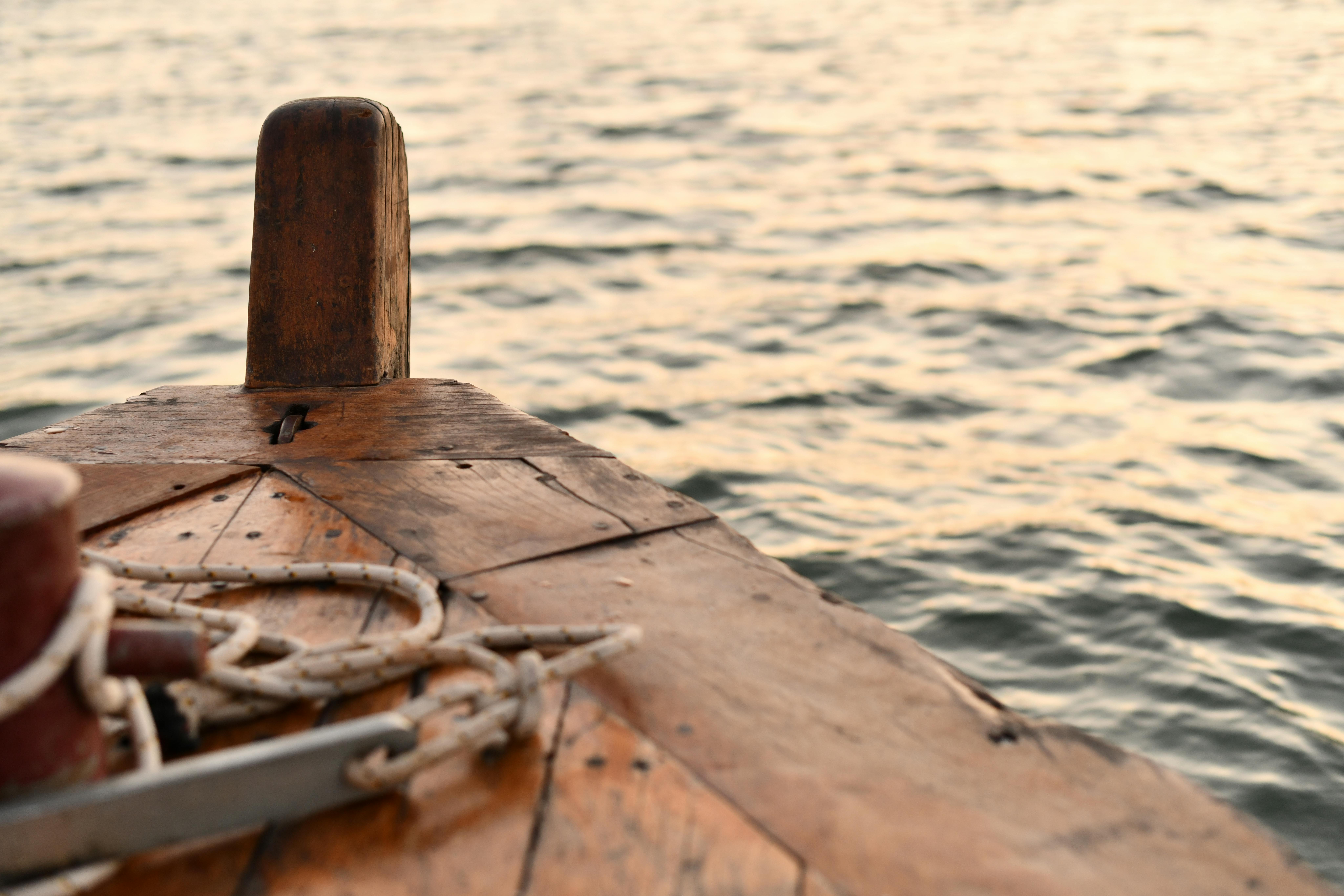Wavy Water behind Wooden Boat Bow · Free Stock Photo