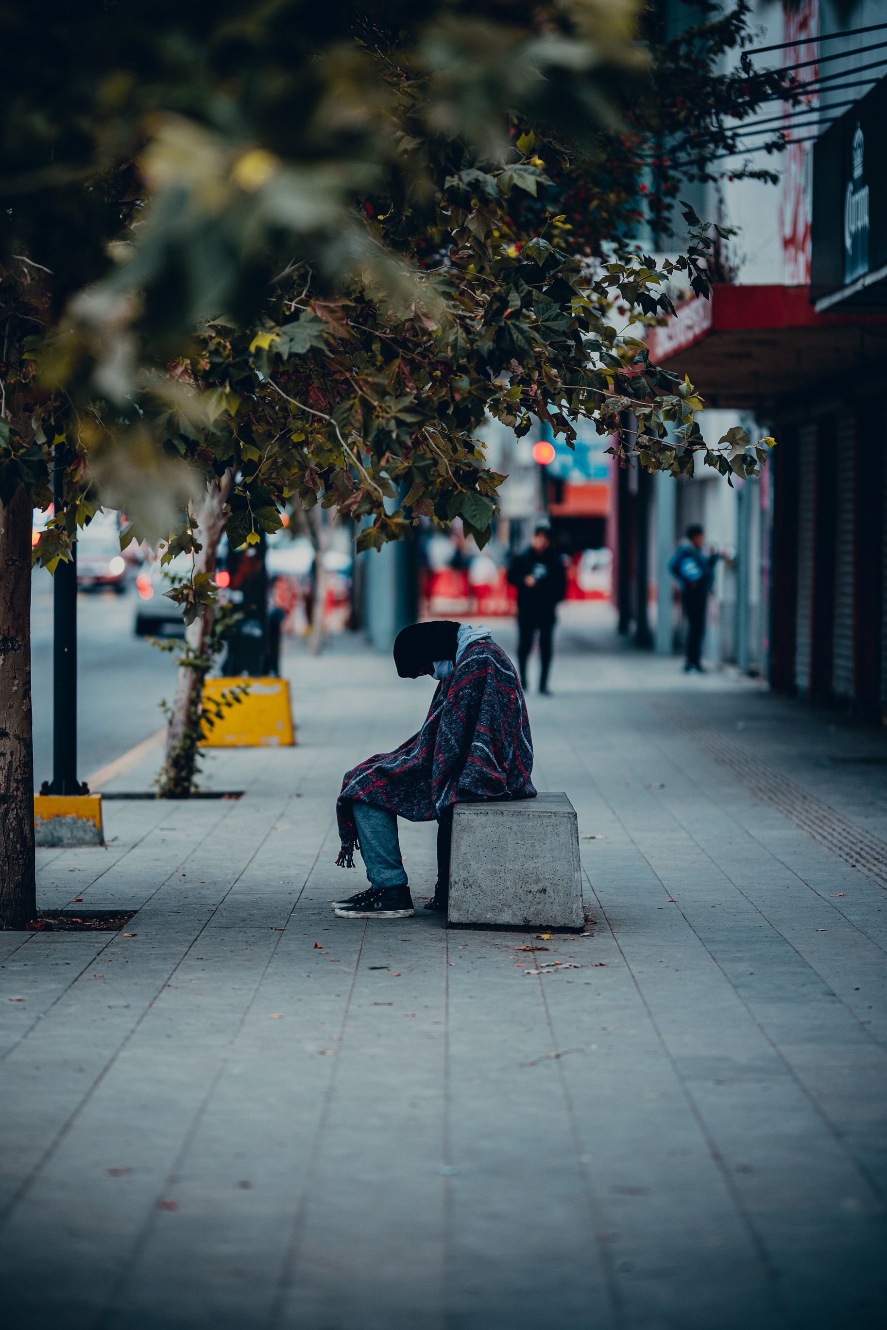 Man Sitting on Bench on a Street · Free Stock Photo