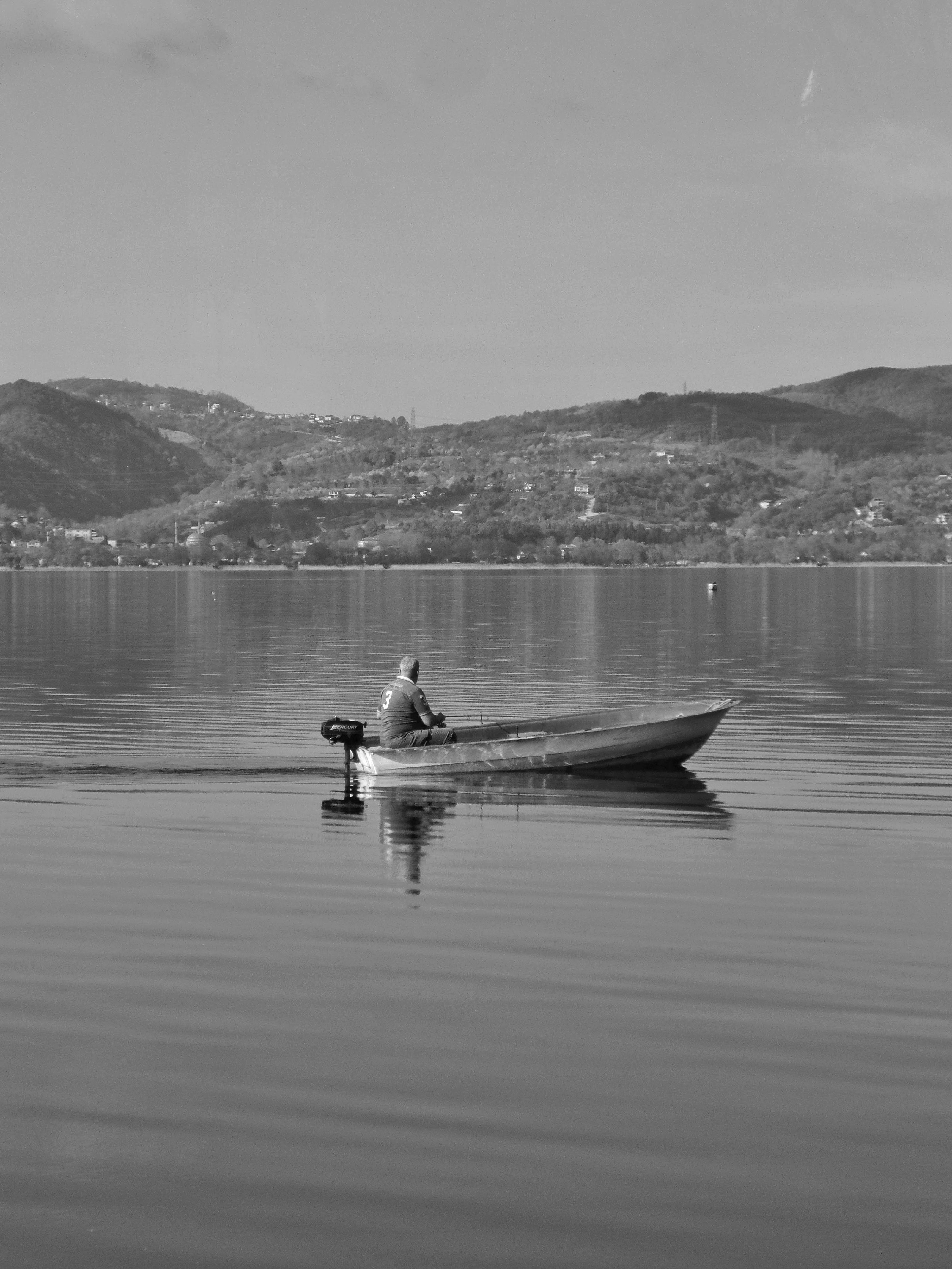 Fisherman Sitting Alone on Boat on Lake · Free Stock Photo