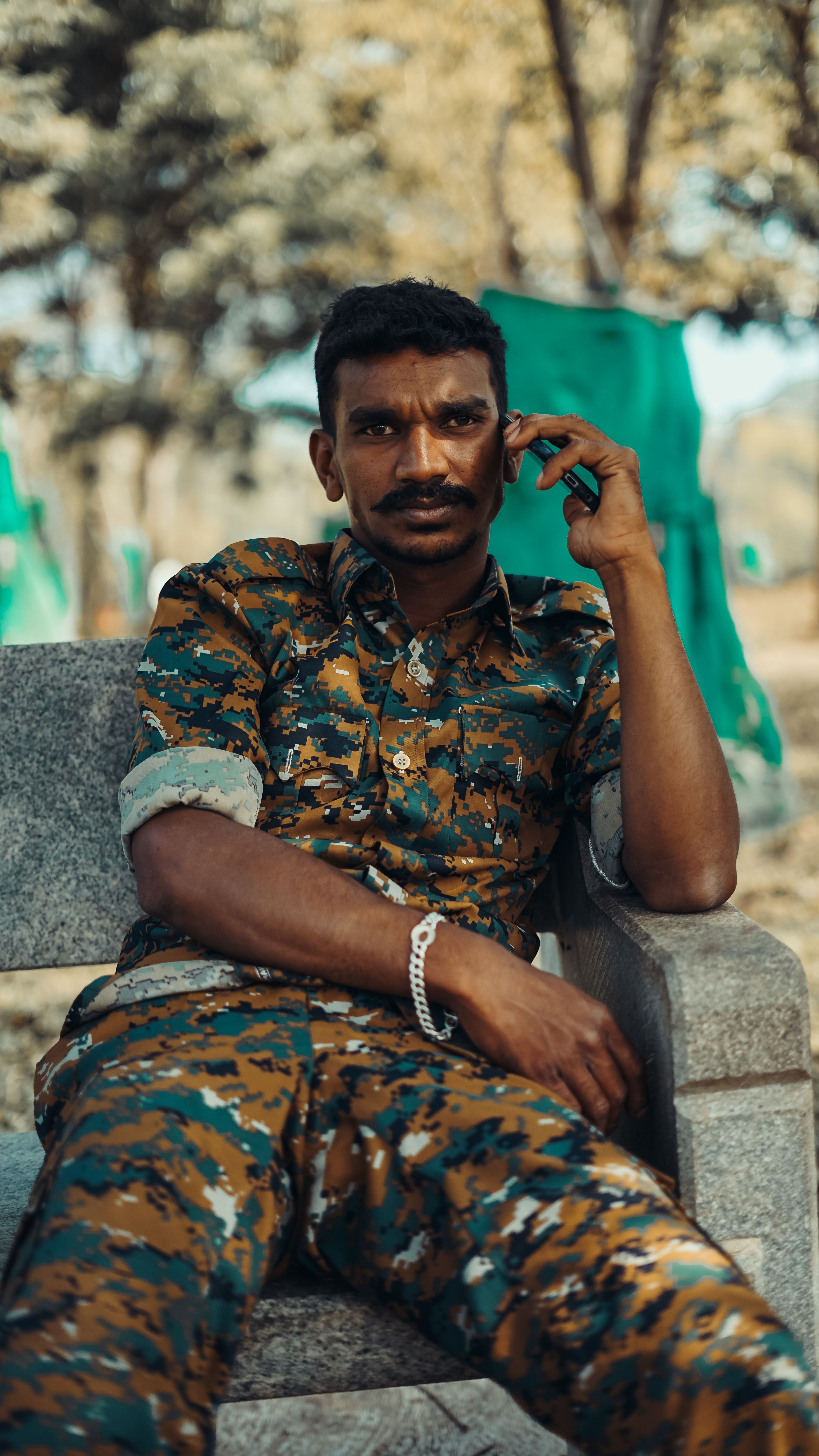 Man Sitting in Military Outfit on Bench · Free Stock Photo