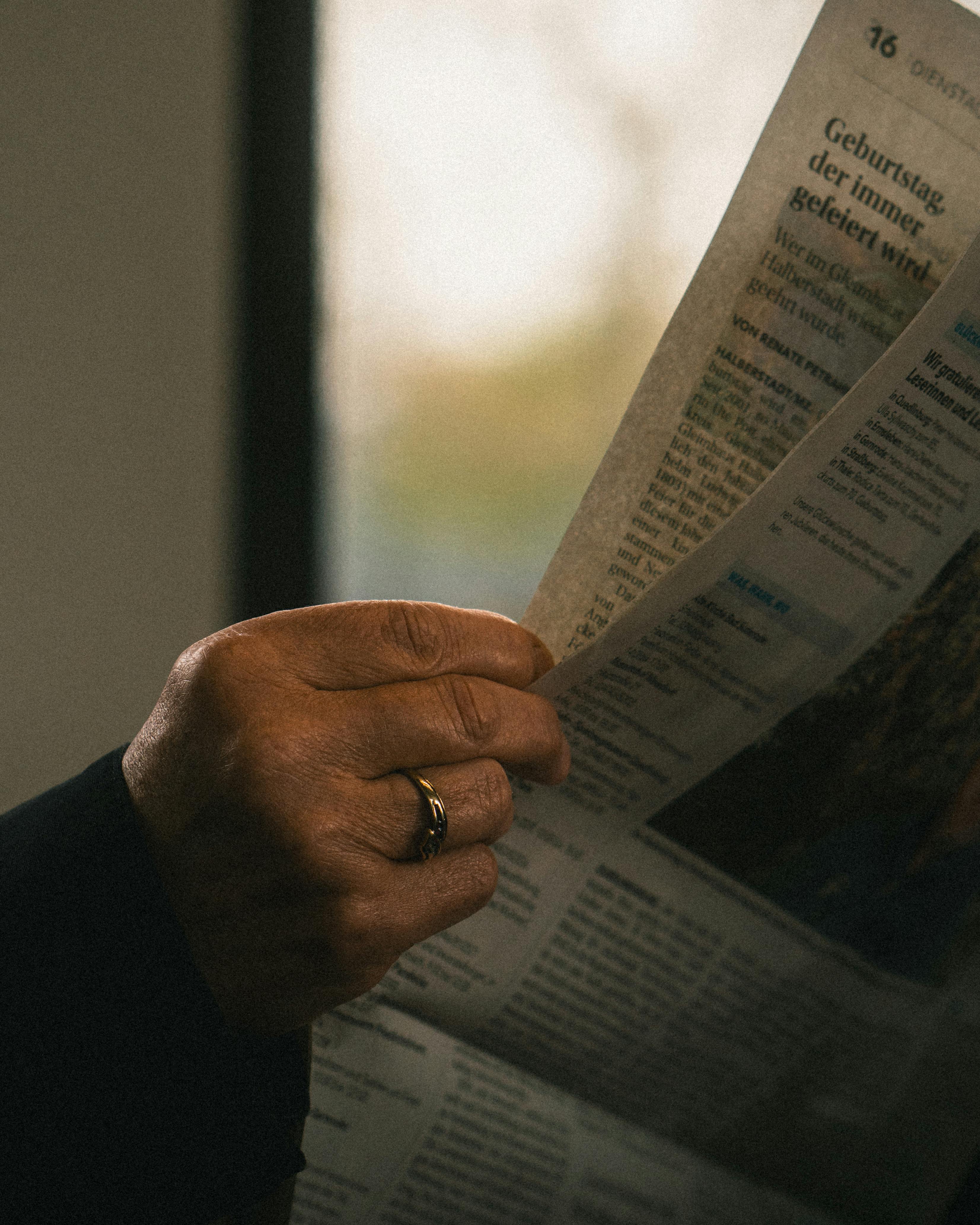Person Hand Holding Newspaper · Free Stock Photo