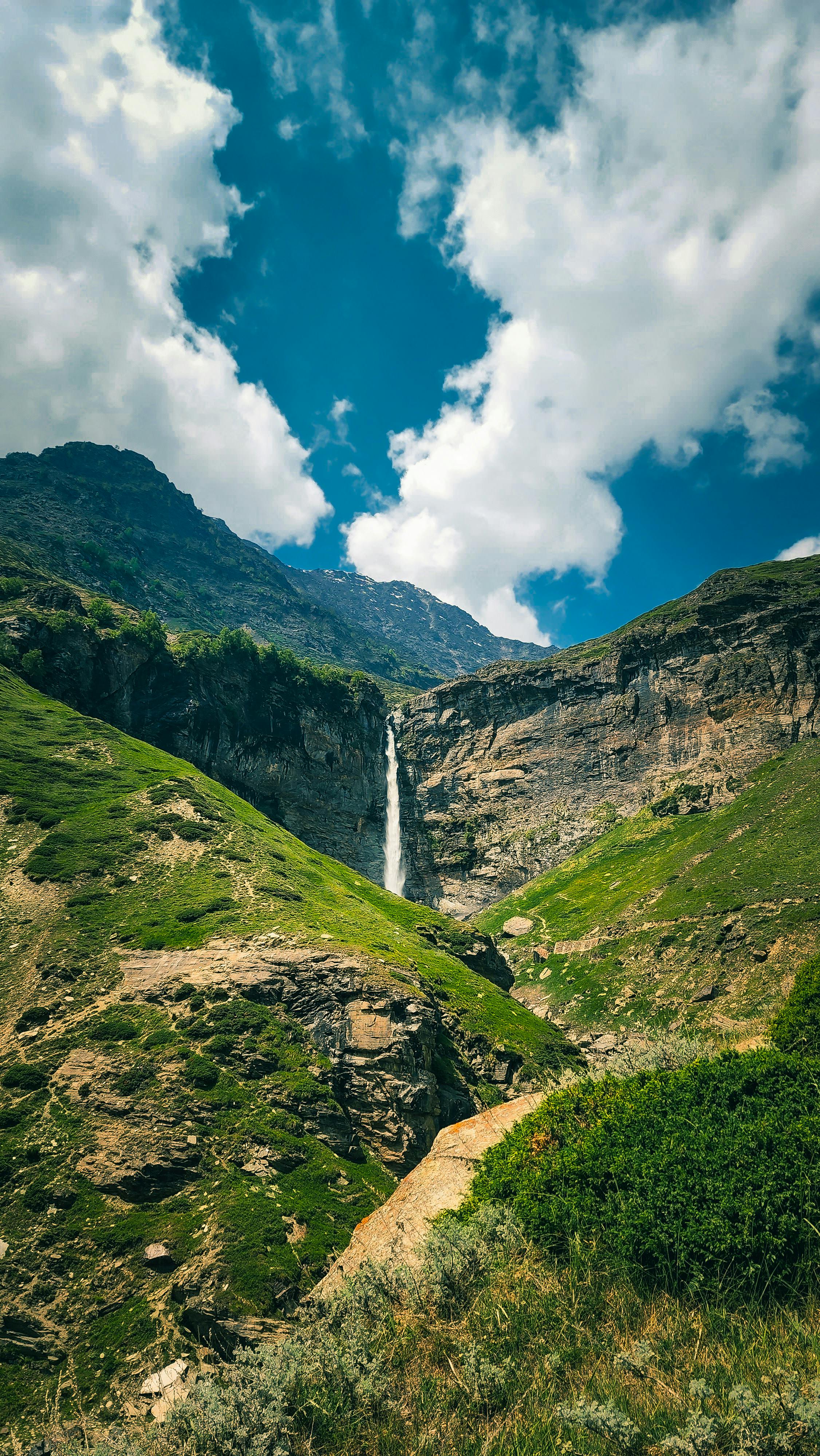 Waterfall on Cliff Near Mountain · Free Stock Photo