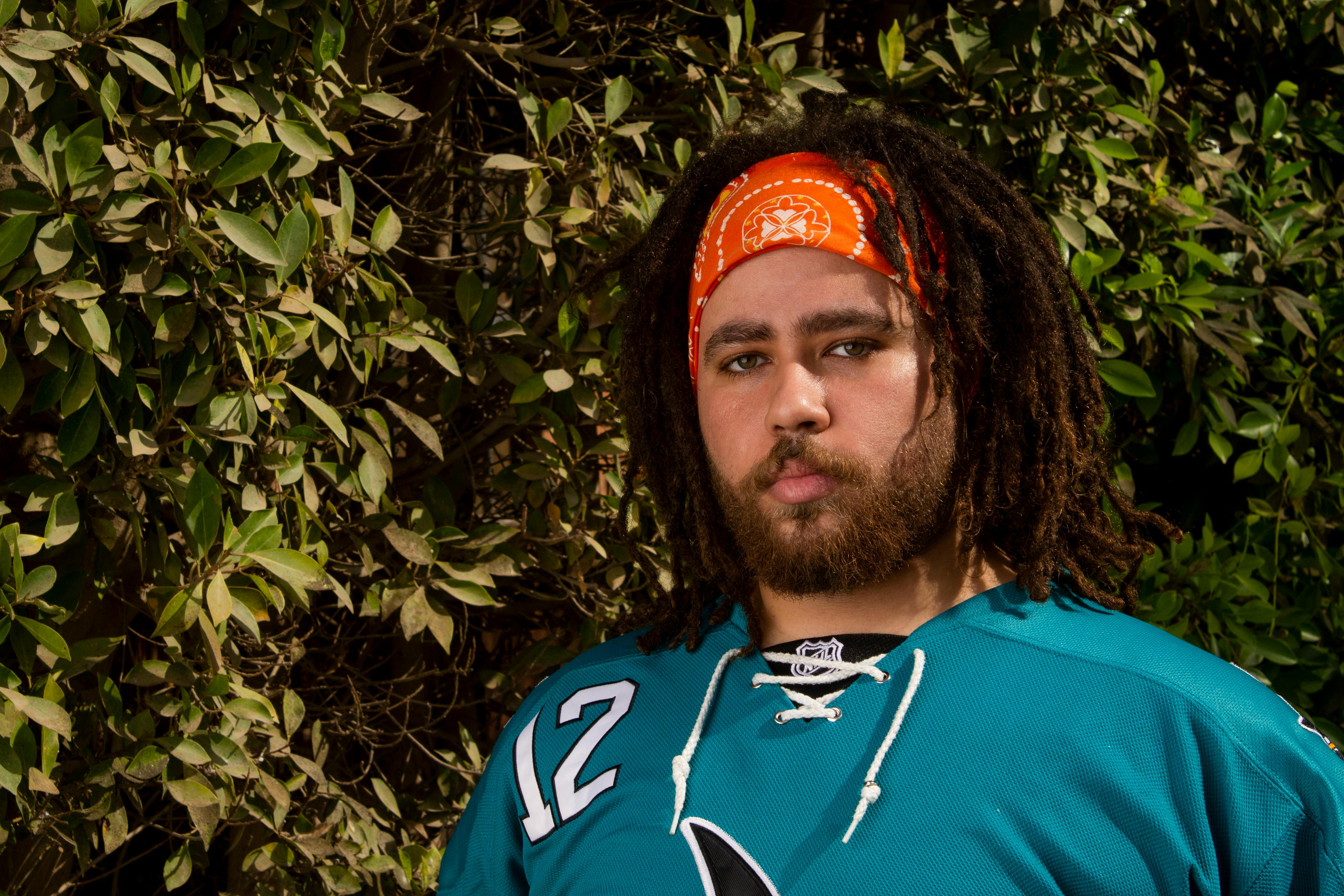 Man with Dreadlocks in a Hockey Jersey and a Red Scarf · Free Stock Photo