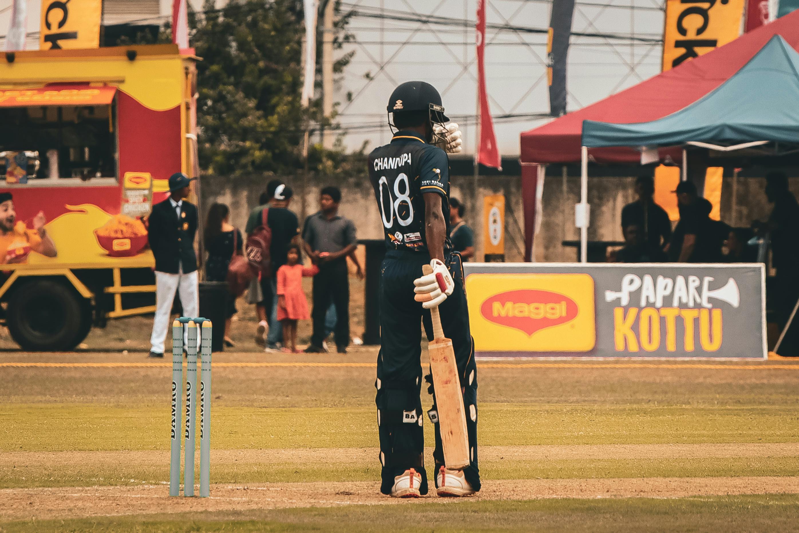 Men Playing Cricket on a Field · Free Stock Photo