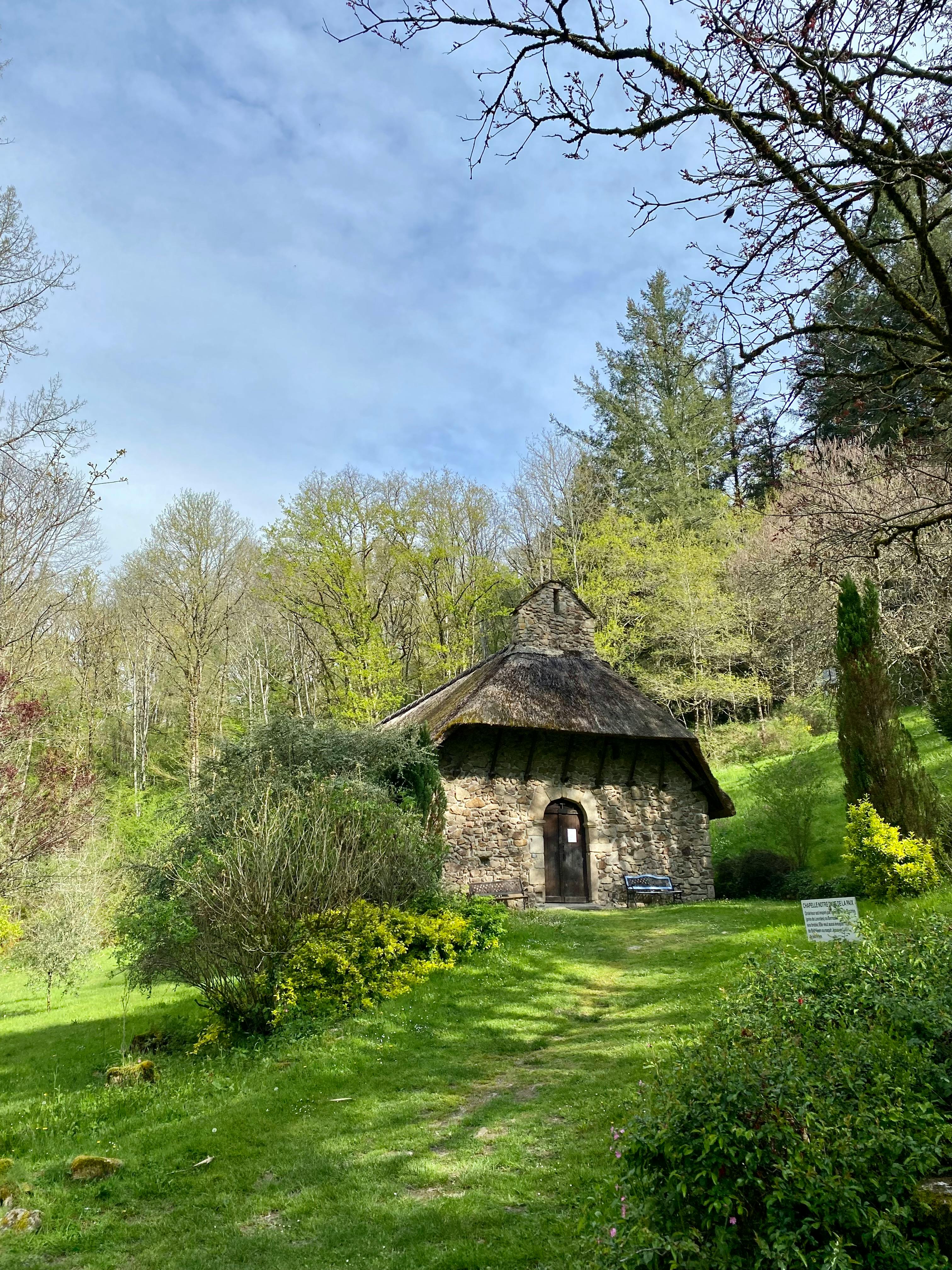 A small stone building in the middle of a lush green field · Free Stock ...
