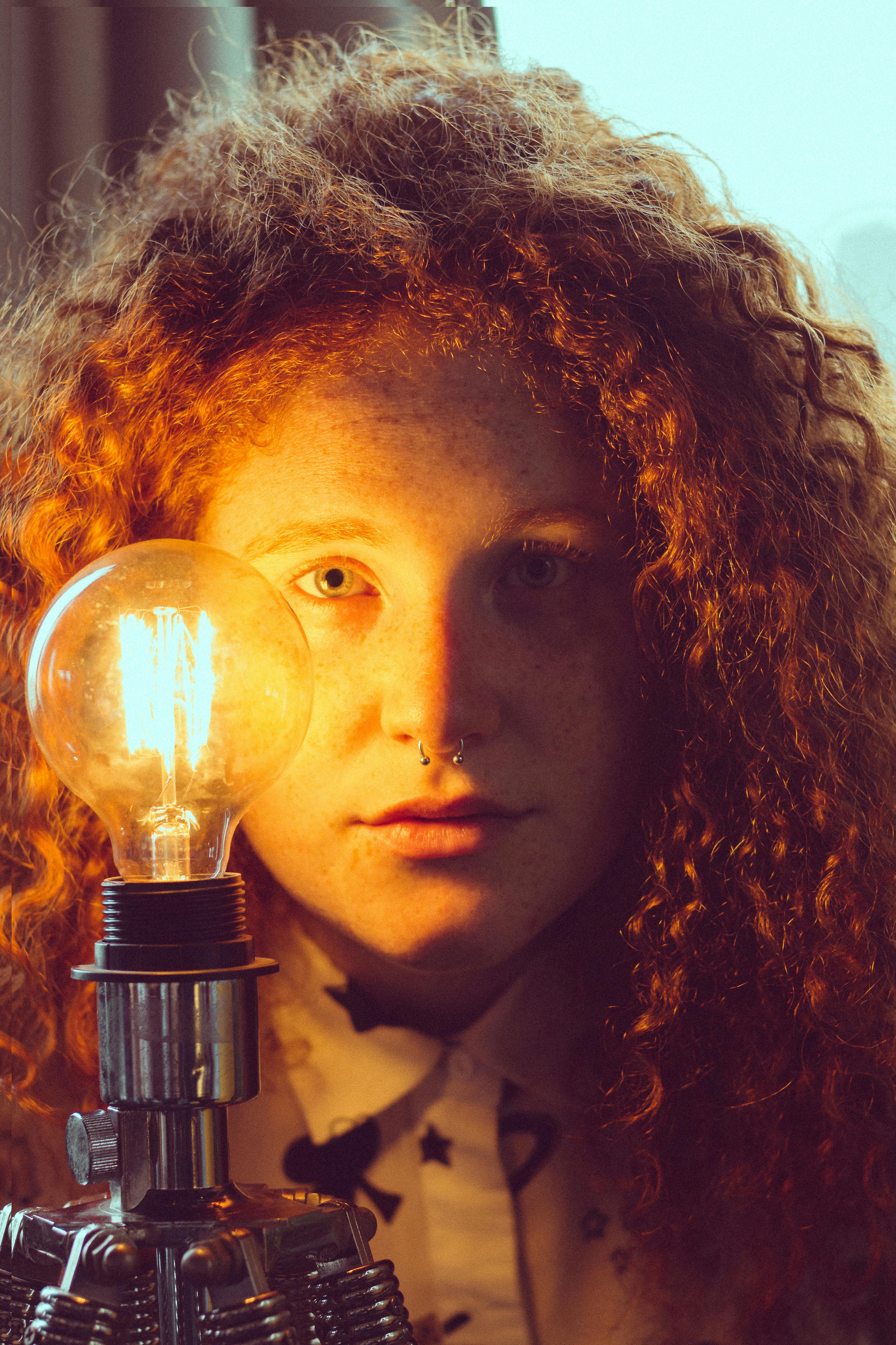 Woman Standing Near Light Bulb · Free Stock Photo