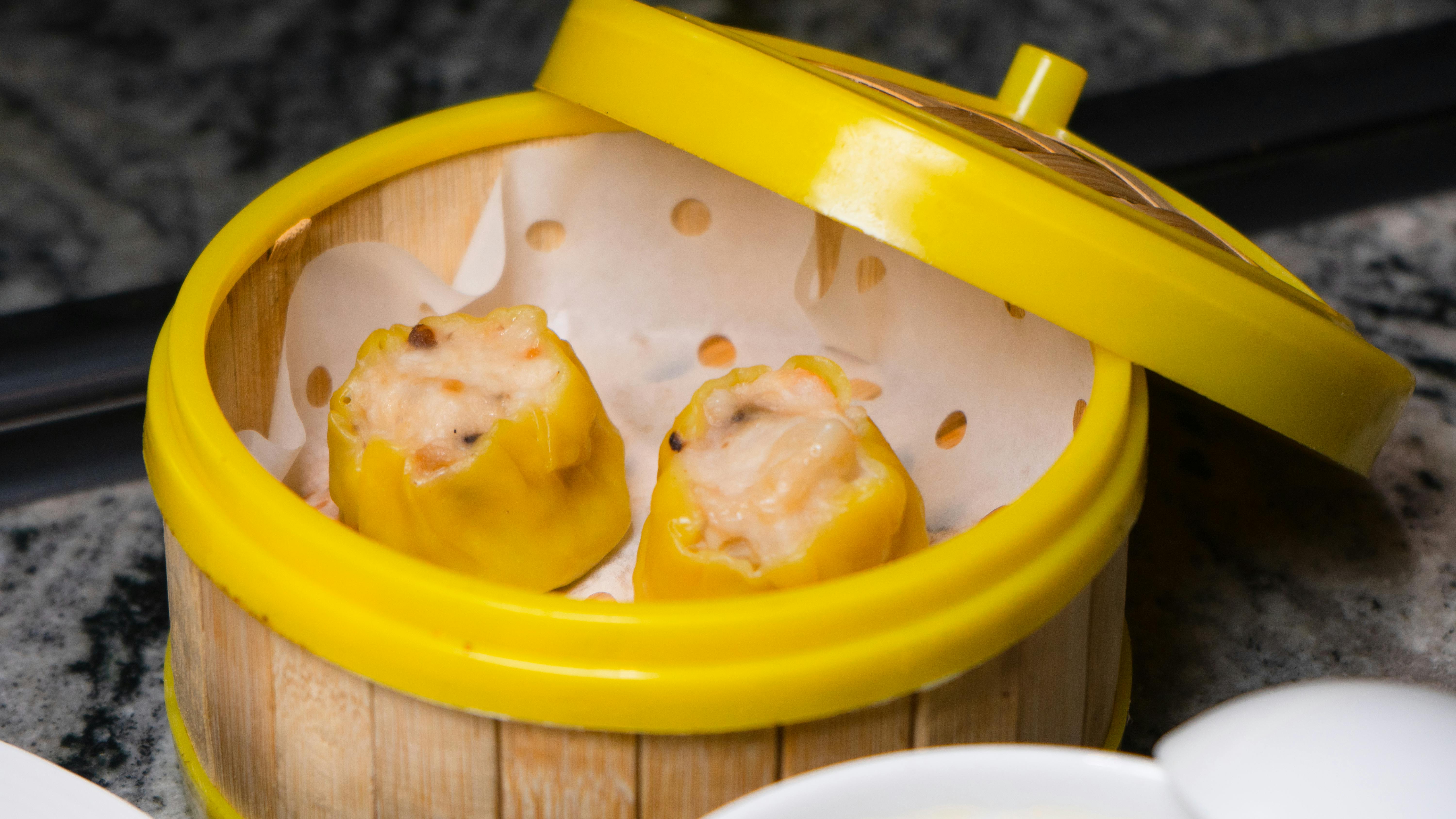 Asian Dumplings in a Yellow Container · Free Stock Photo
