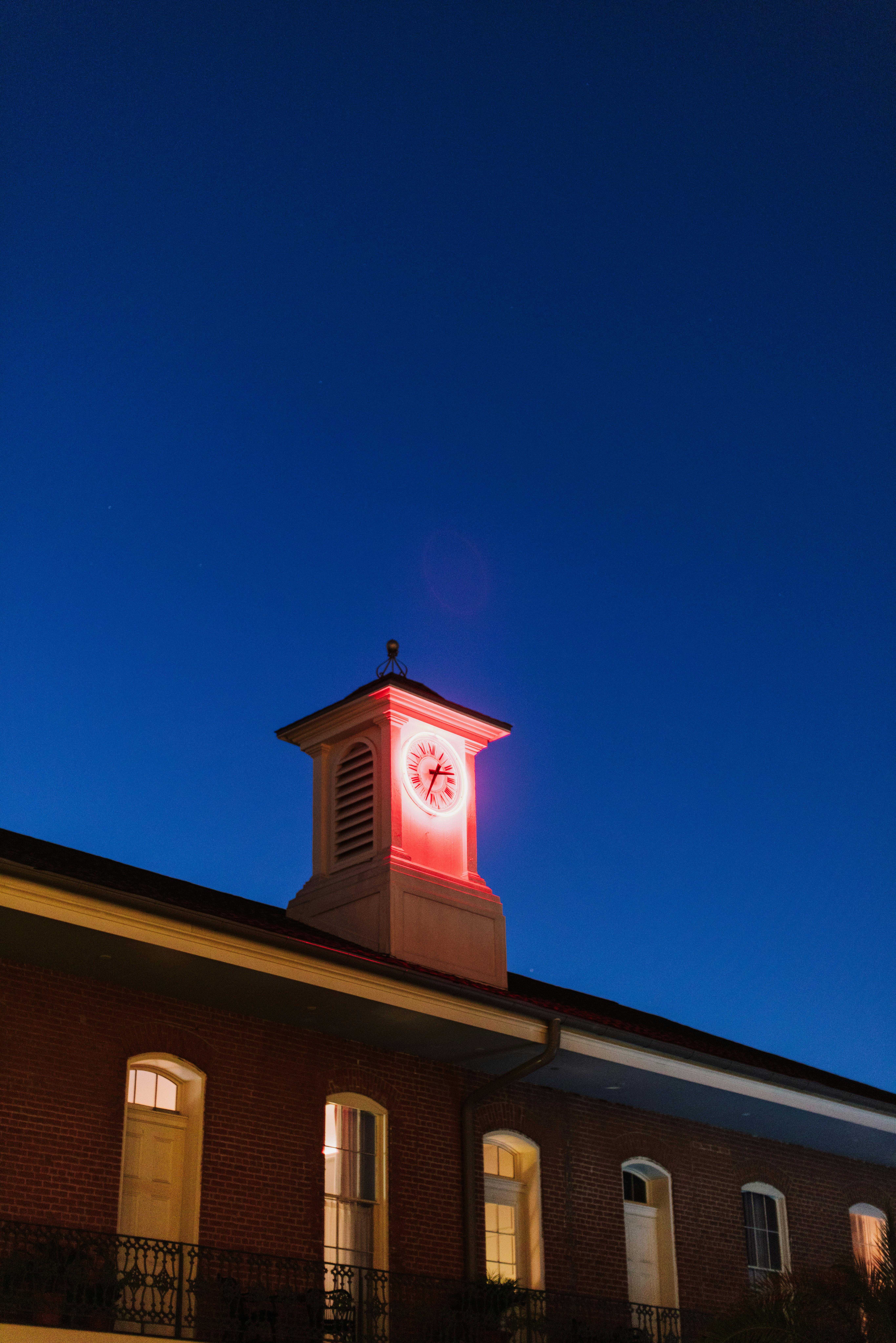 A clock tower with a red light on top · Free Stock Photo