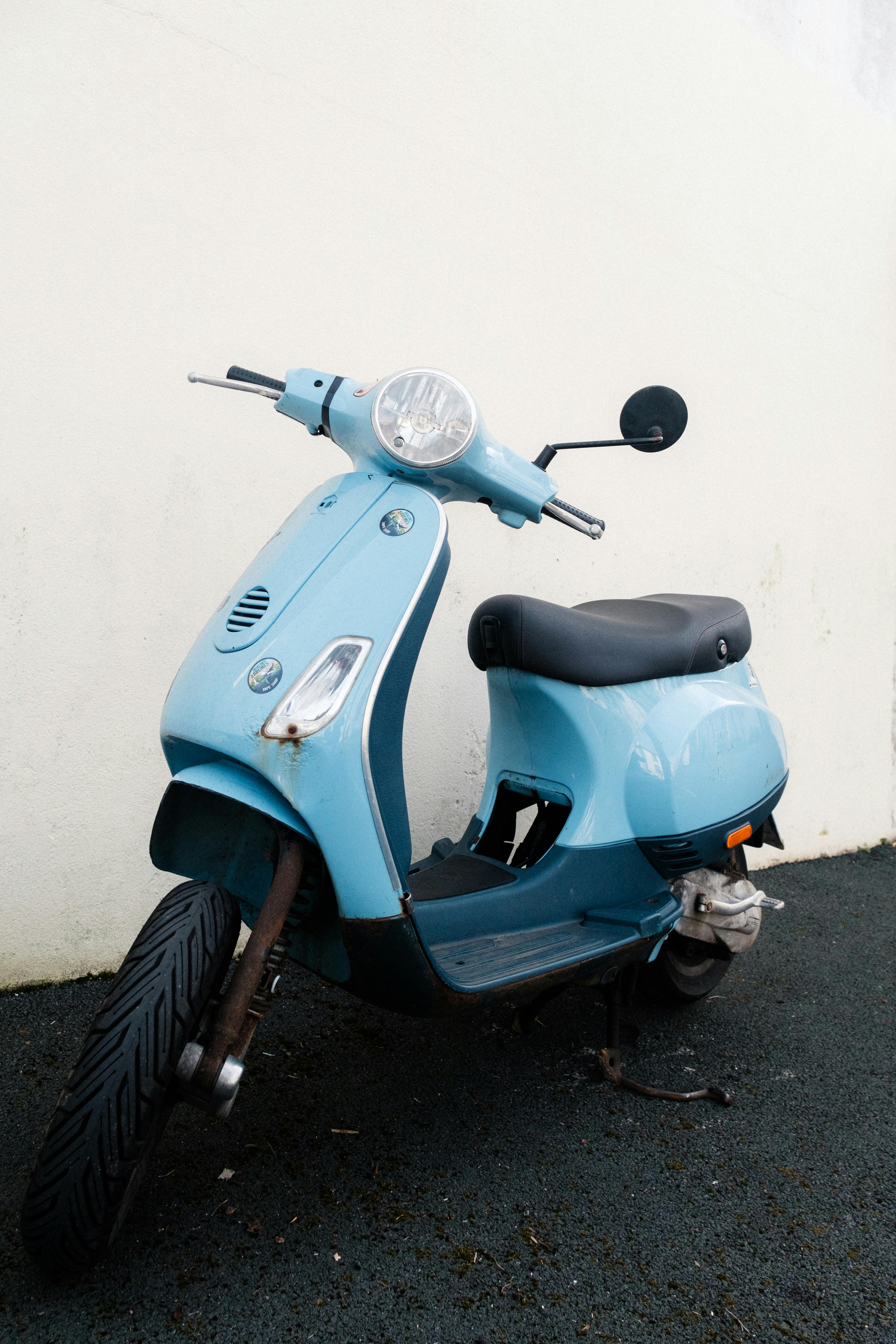 Blue Scooter Parked by a Wall · Free Stock Photo