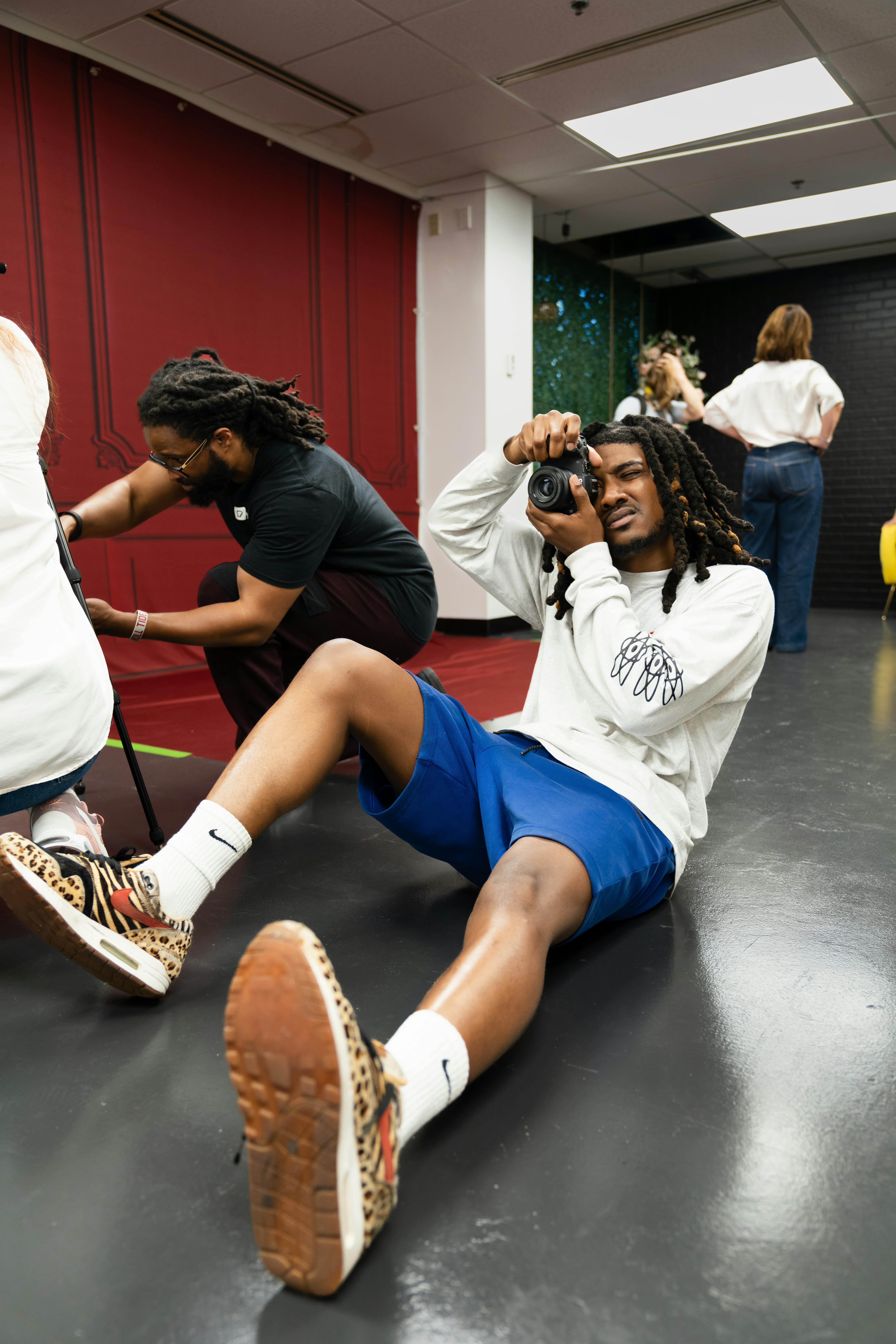 Young Man Doing a Picture with a Camera Sitting on the Ground · Free ...