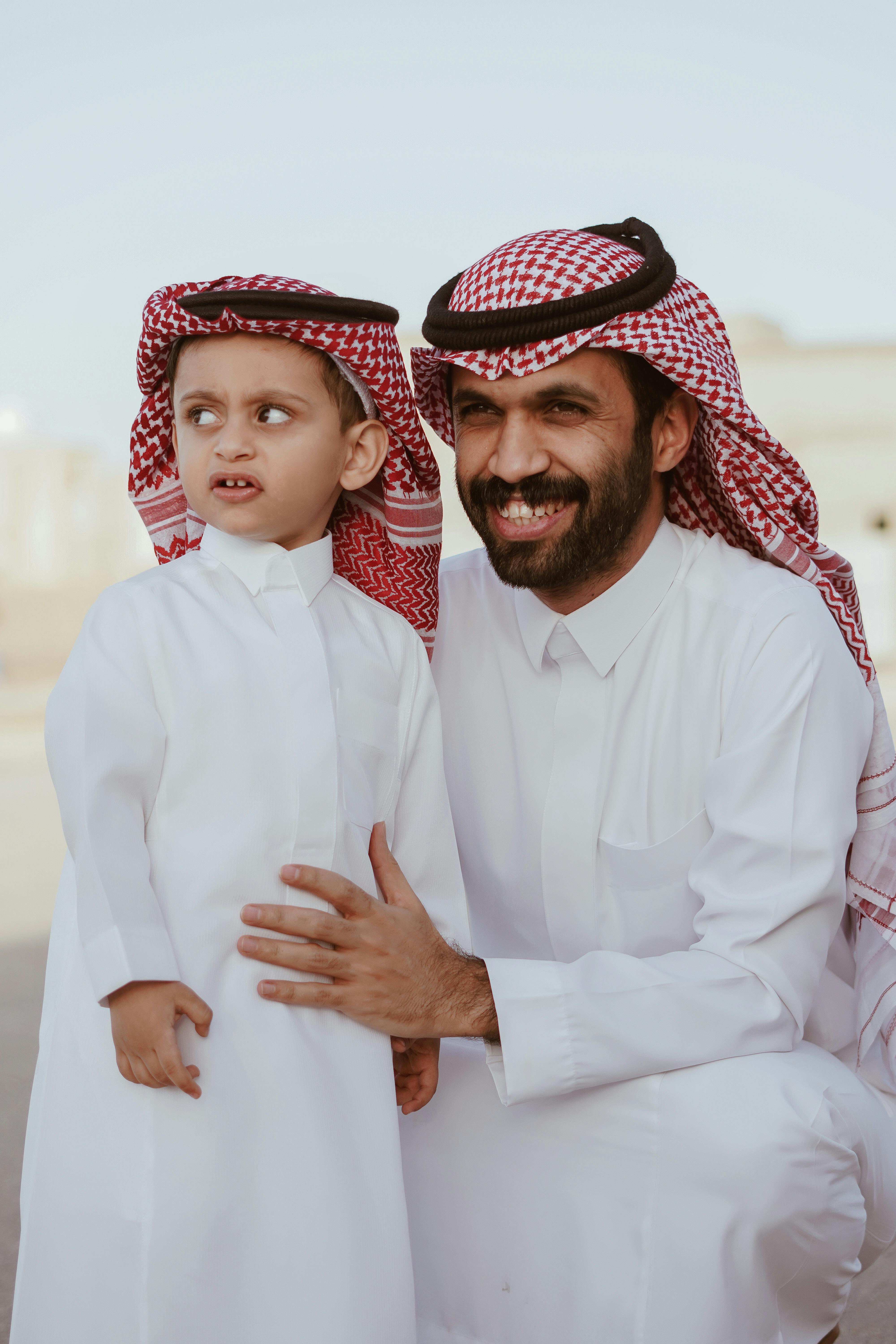 Smiling Father with Son in Traditional Clothing · Free Stock Photo