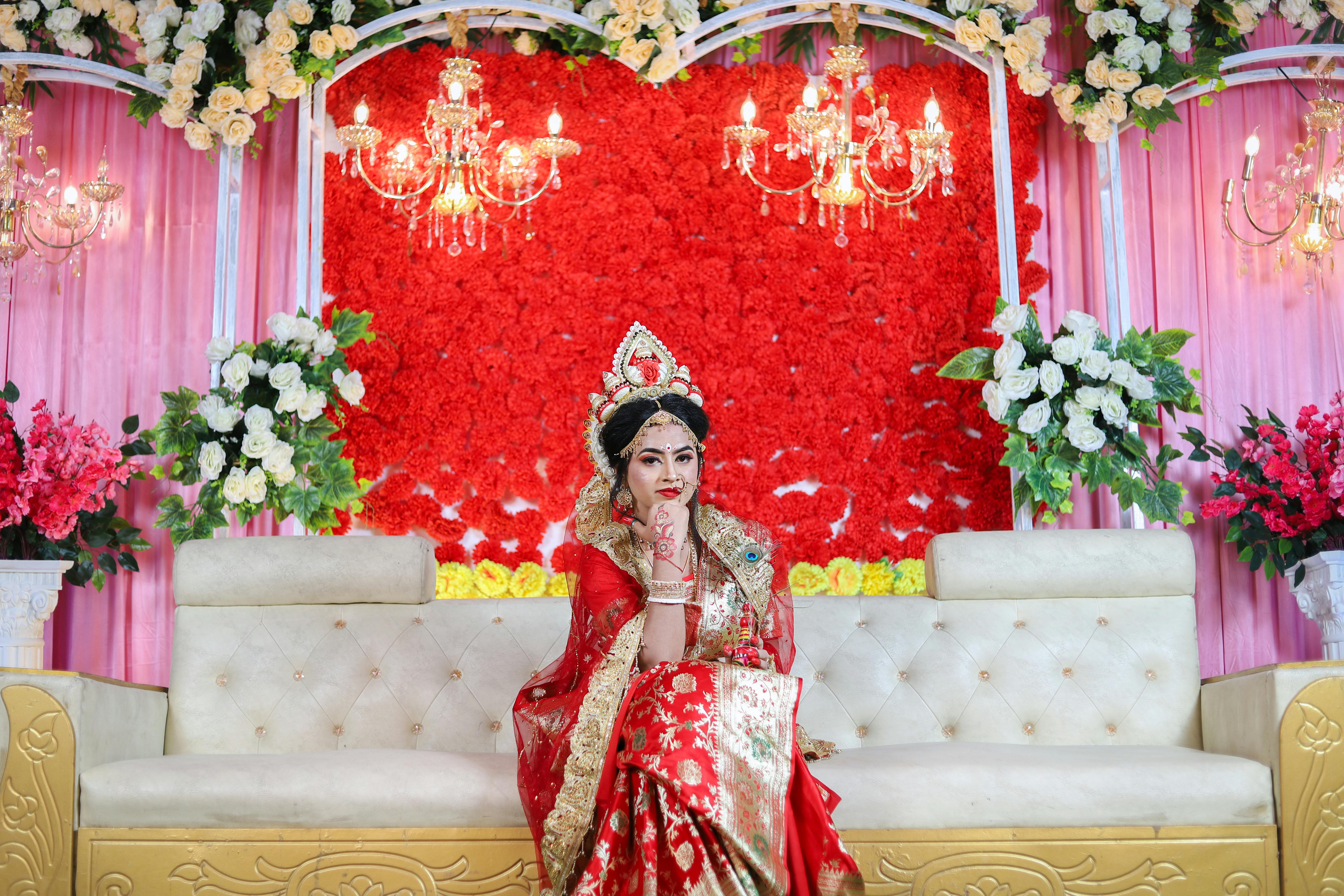 Bride in Traditional Dress Sitting on Sofa · Free Stock Photo