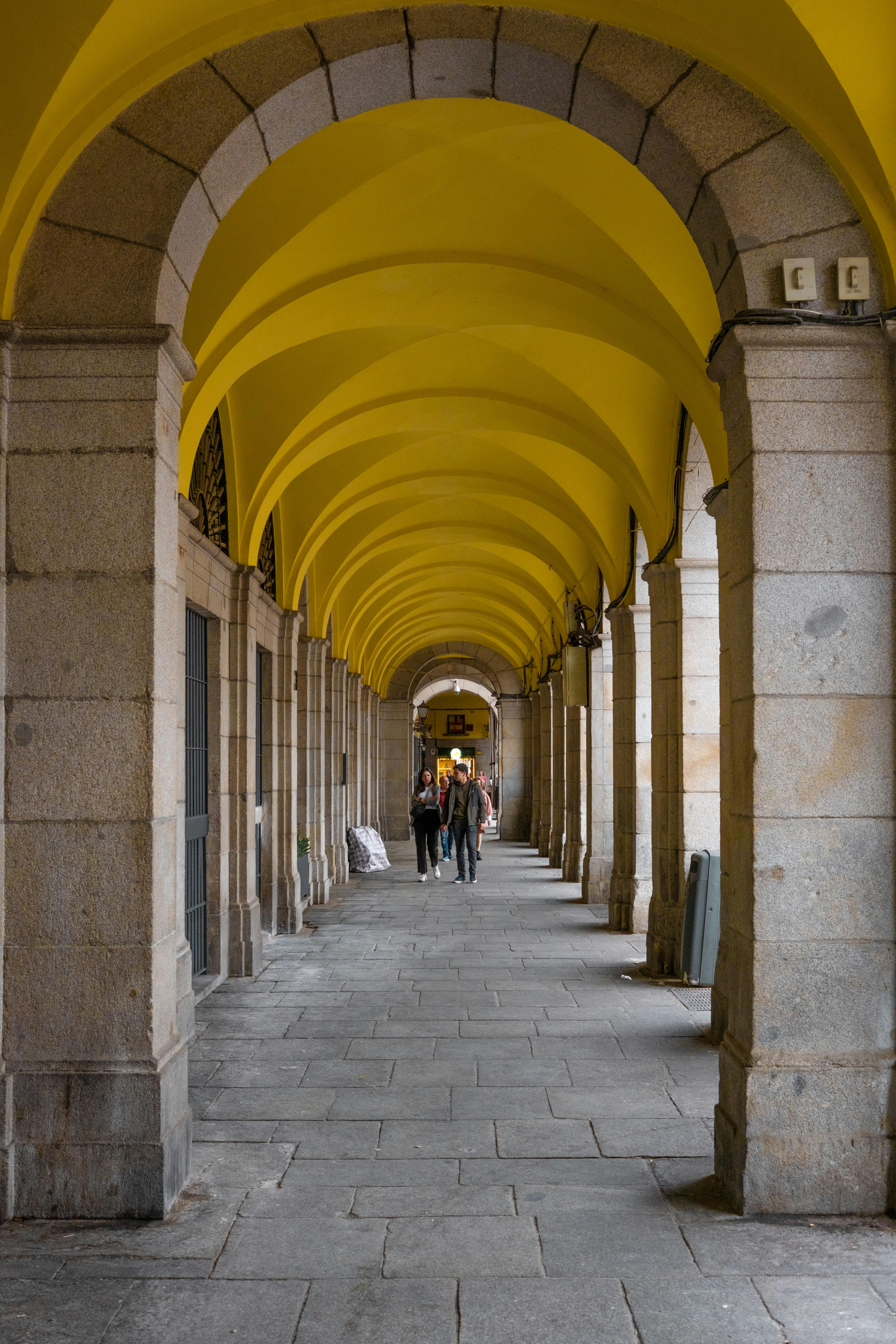 People Walking under Building Arches · Free Stock Photo