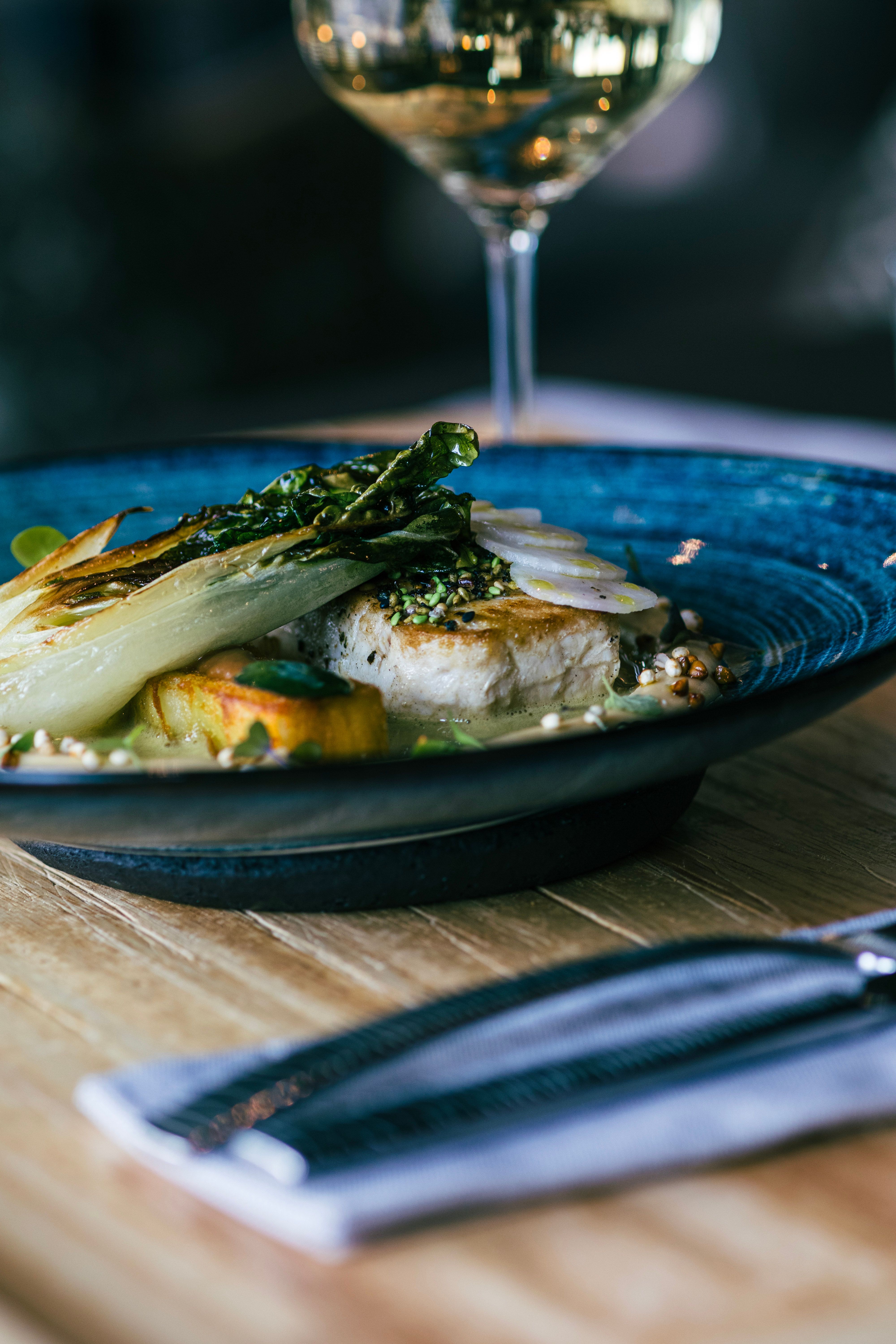 Fish Served with Pak Choi on Blue Table · Free Stock Photo
