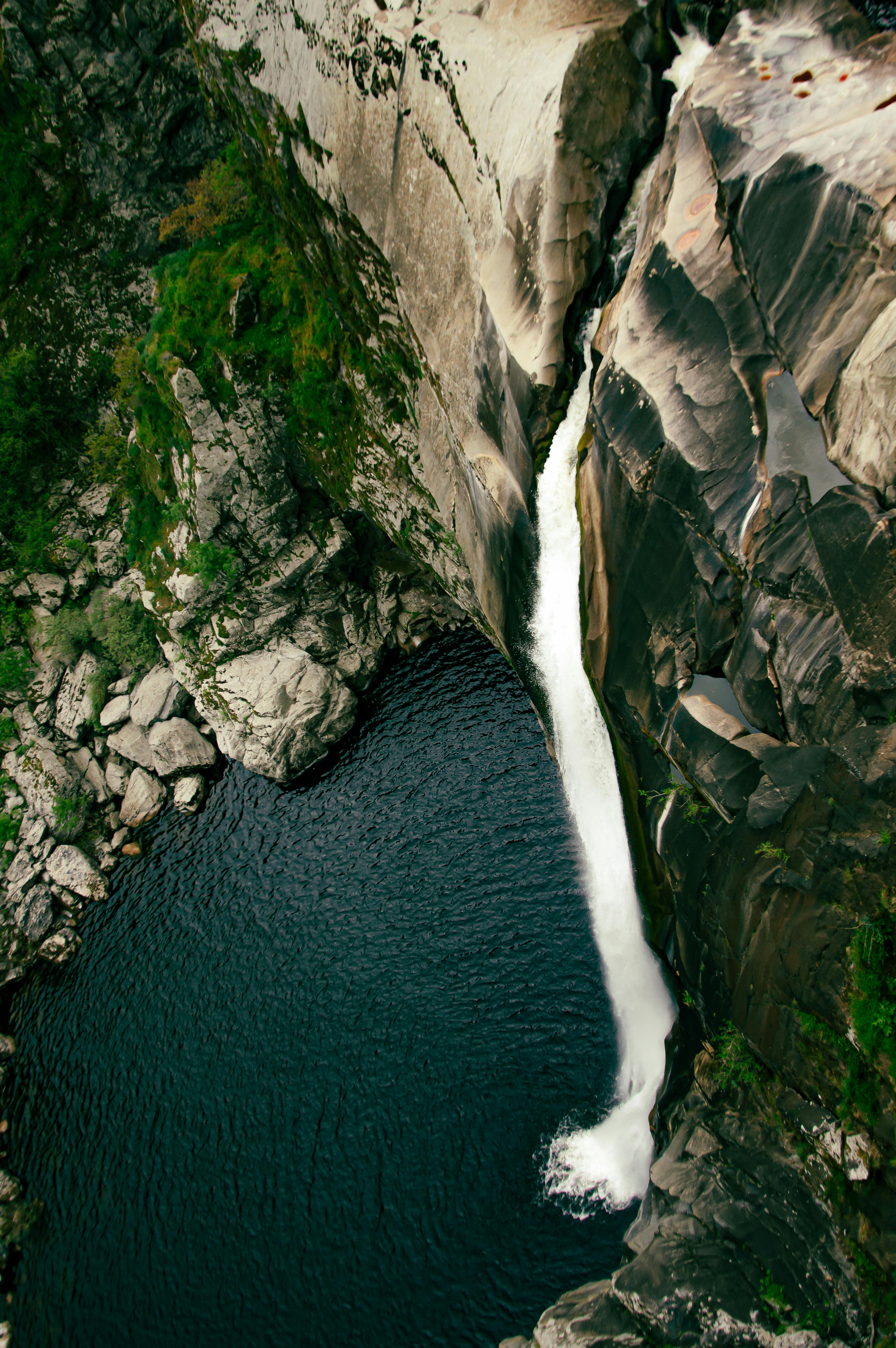 Aerial View of Waterfall Pooling by Cliff · Free Stock Photo