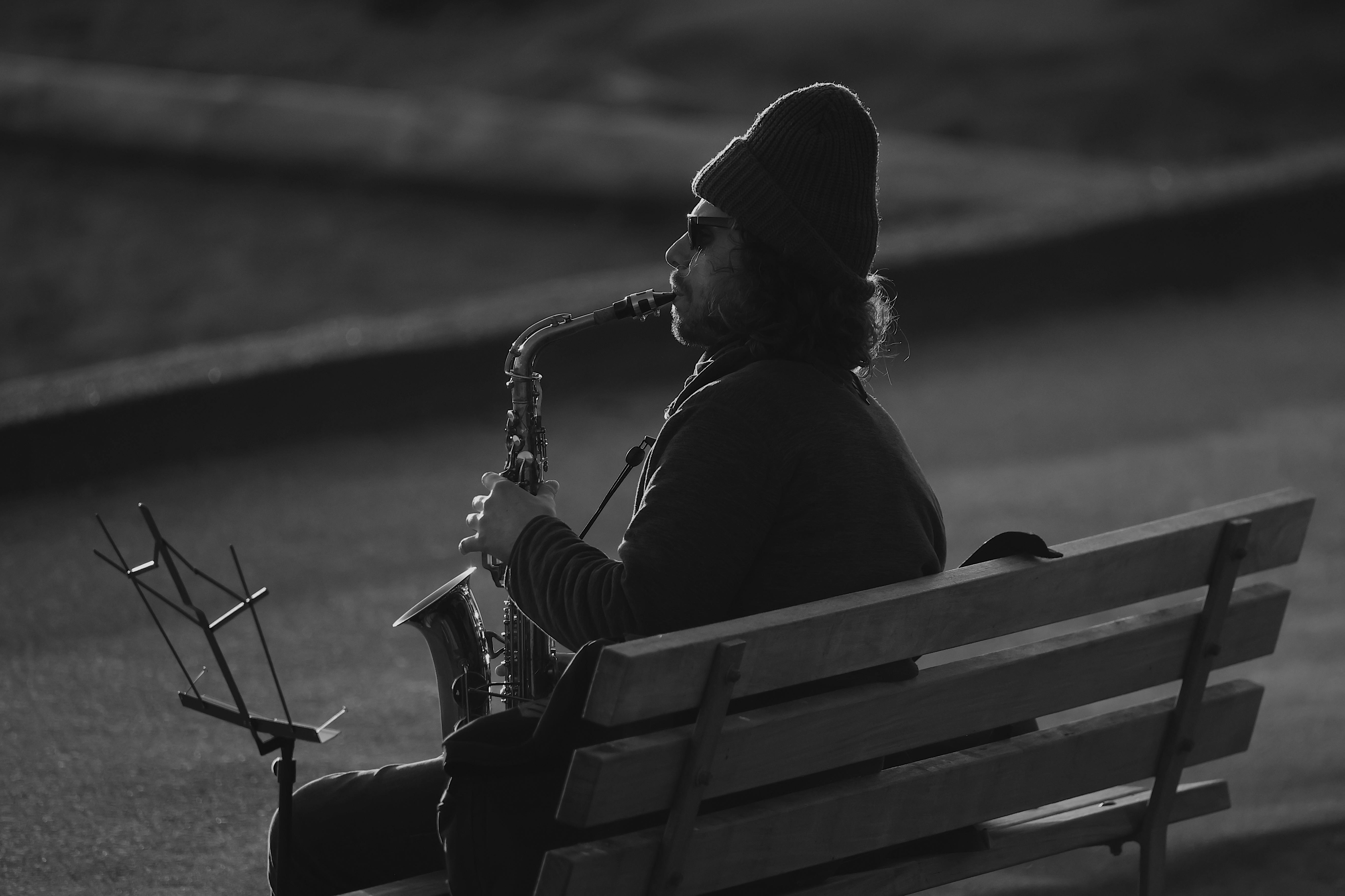Man Playing Saxophone on Bench · Free Stock Photo