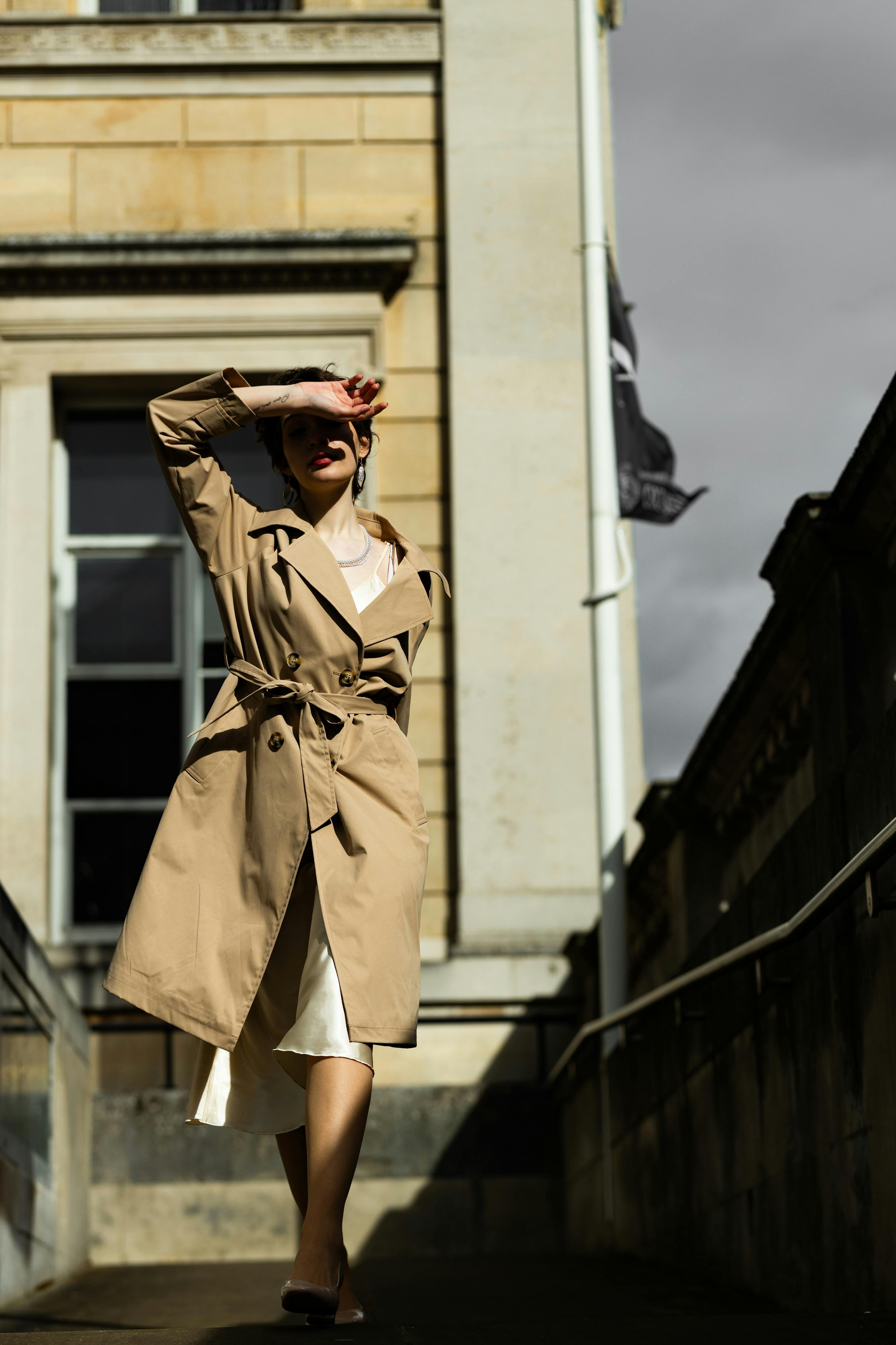 A woman in a trench coat and hat · Free Stock Photo