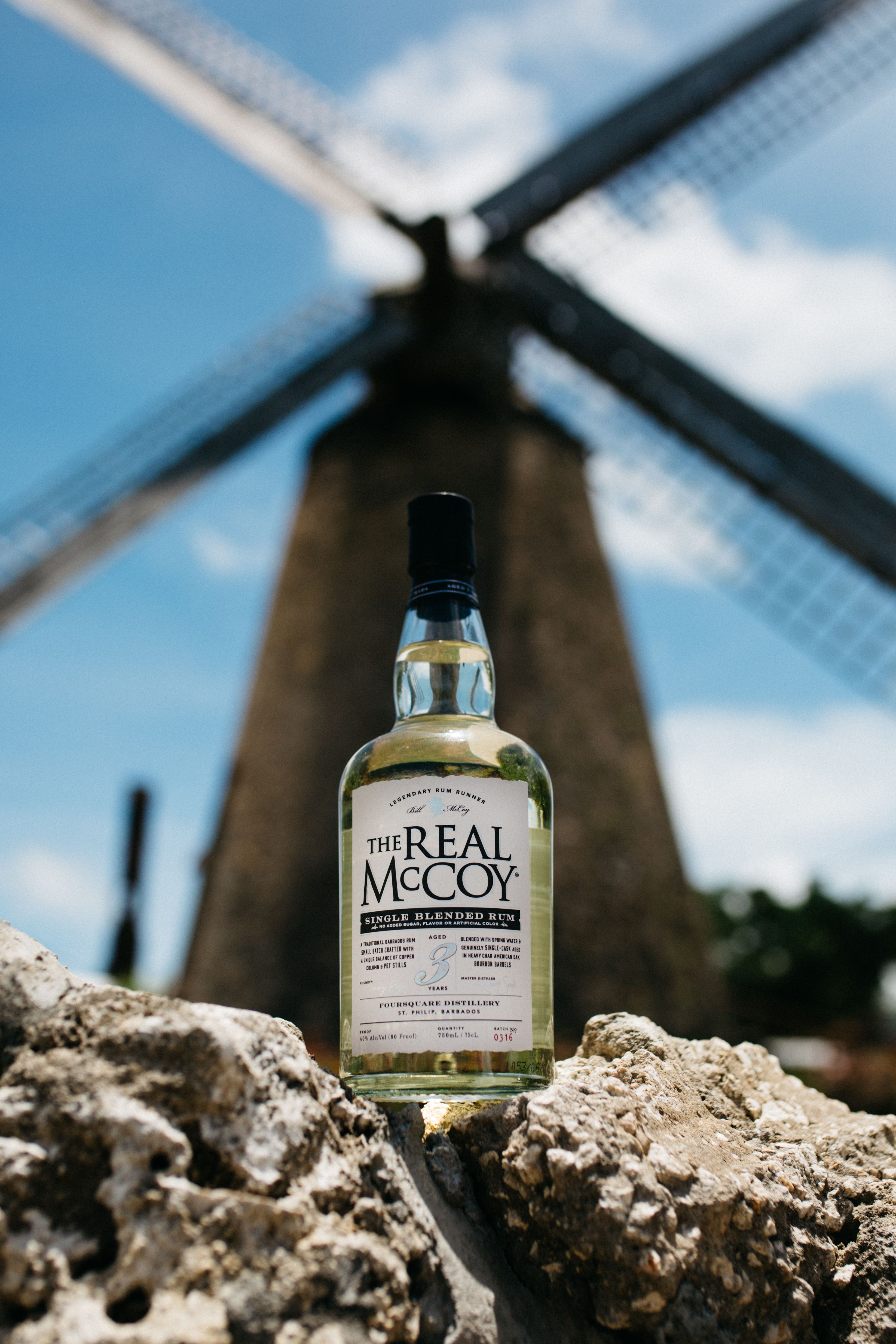 Bottle of Brand Rum against Windmill · Free Stock Photo