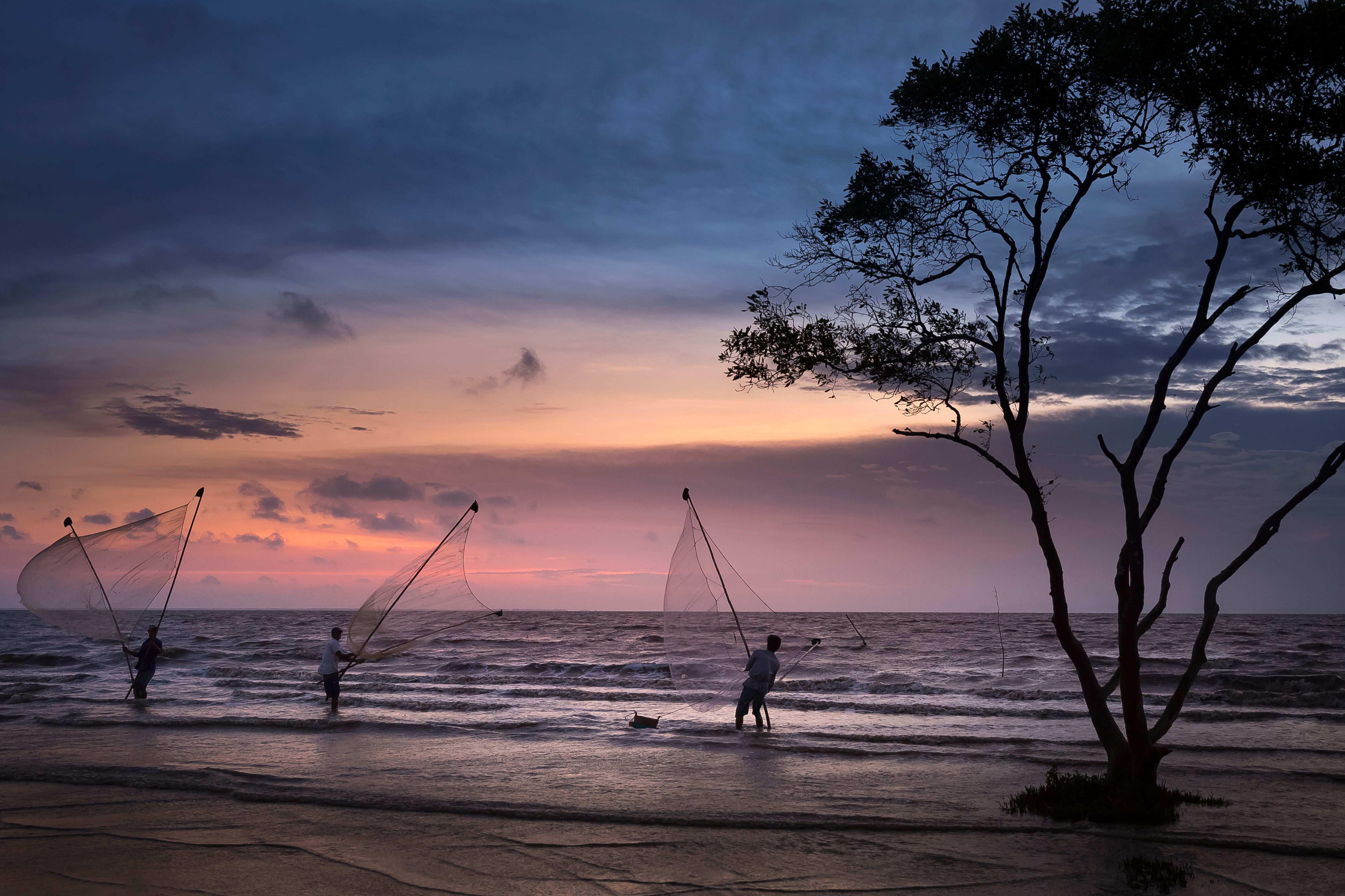 Three Fishermen fishing during Sunset · Free Stock Photo