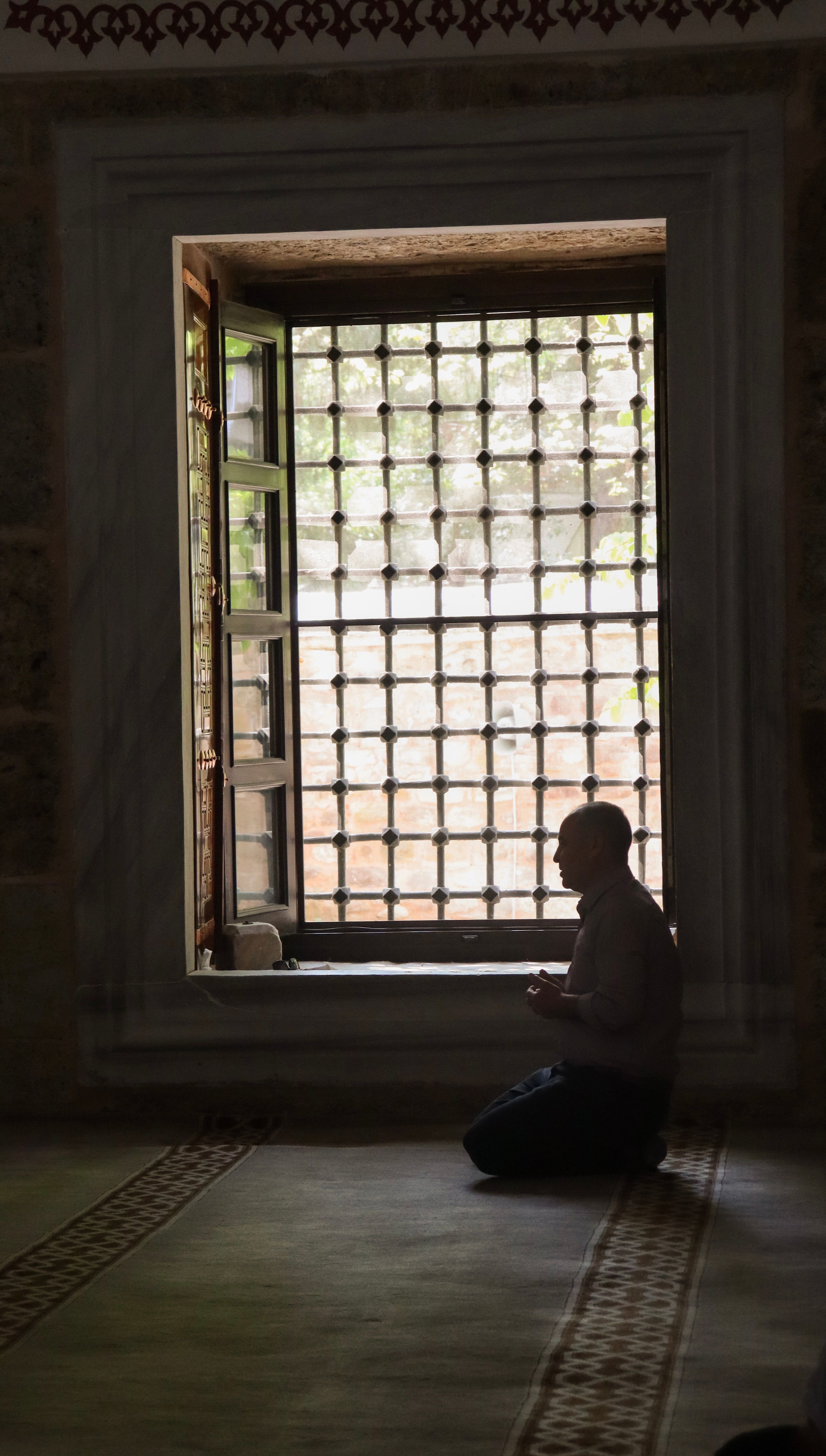Man Praying in a Room with a Window · Free Stock Photo