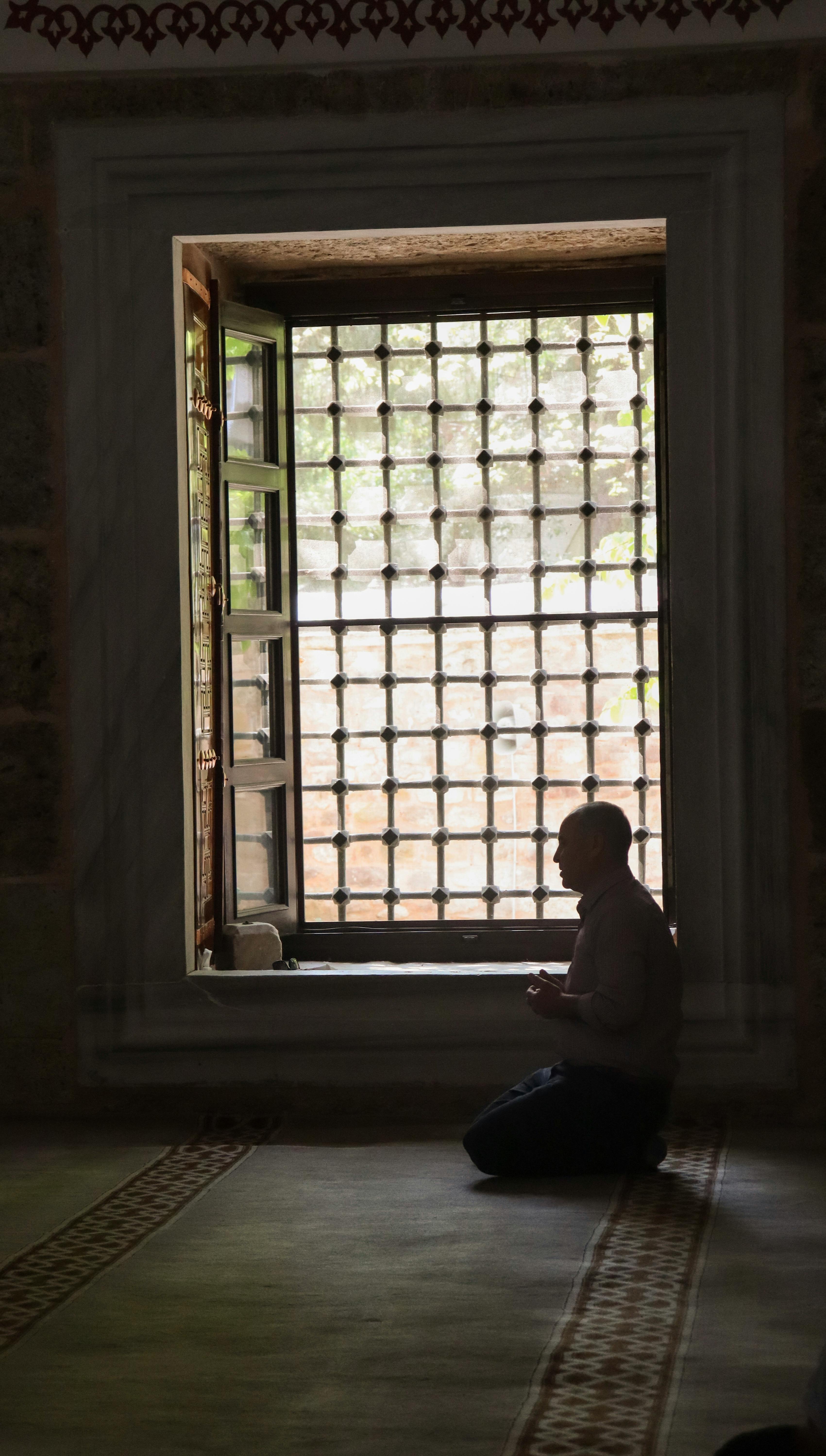 Man Praying in a Room with a Window · Free Stock Photo