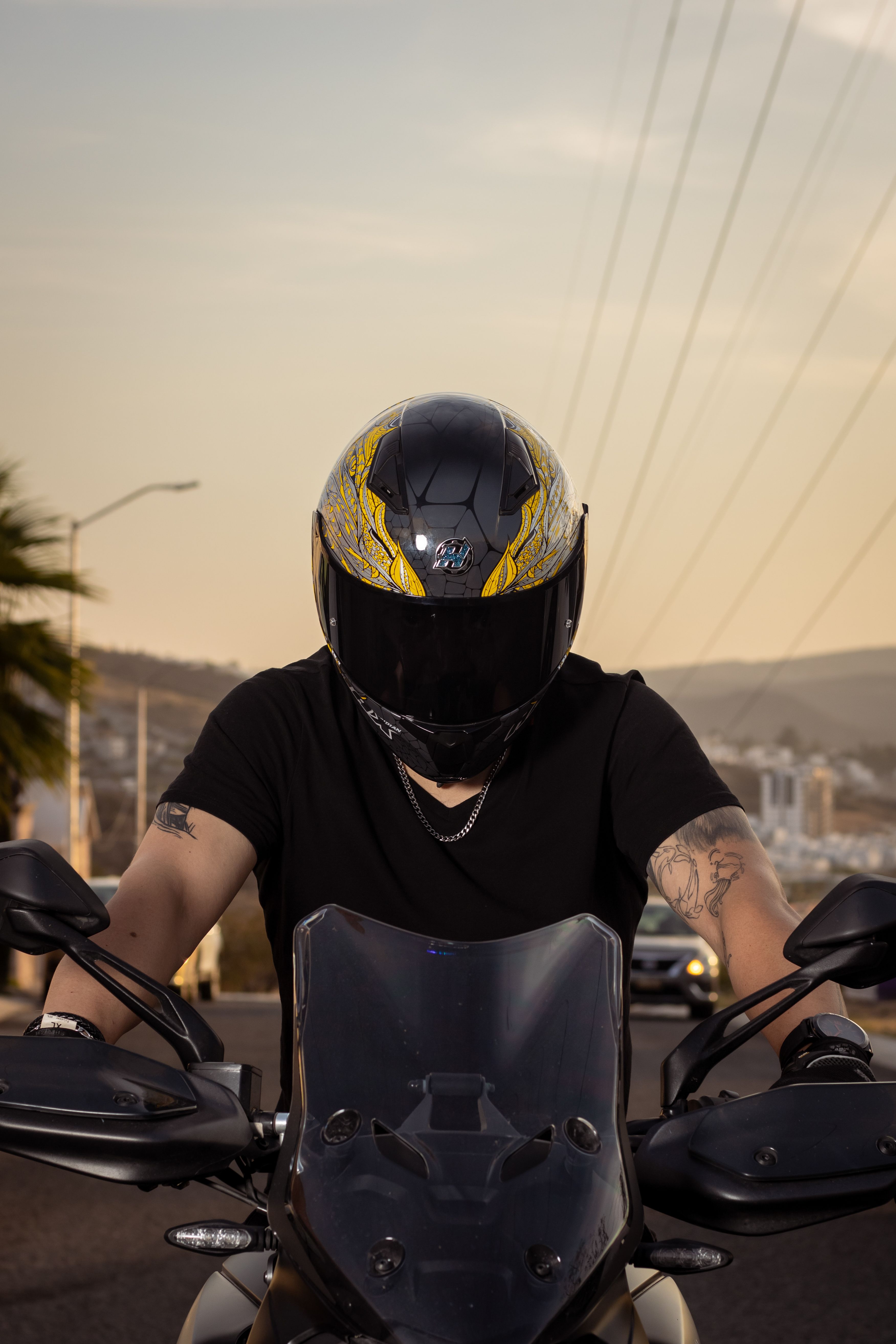 Motorcyclist with Helmet Posing on Motorcycle on Street · Free Stock Photo
