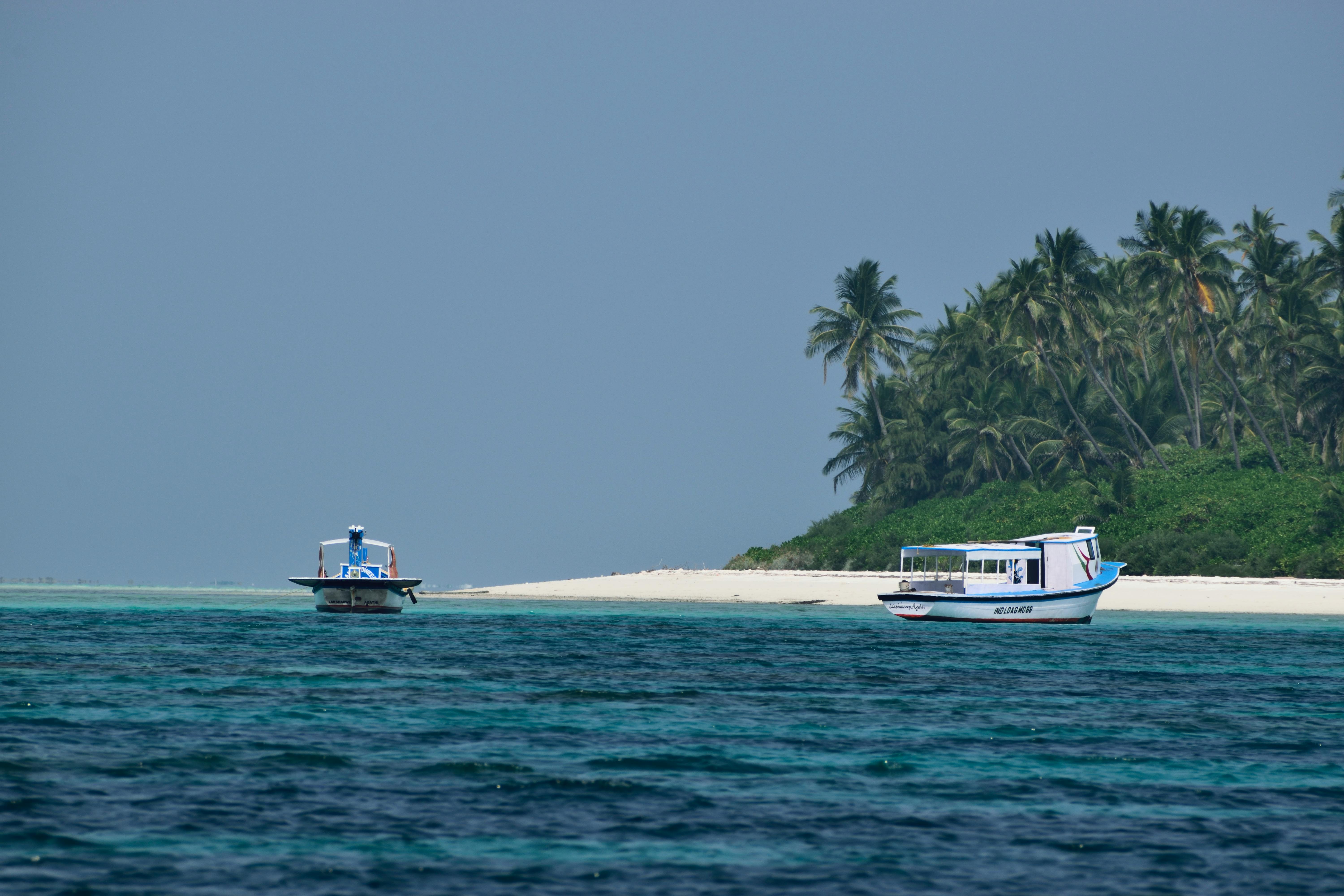View of Two Boats near the Shore of a Tropical Island · Free Stock Photo
