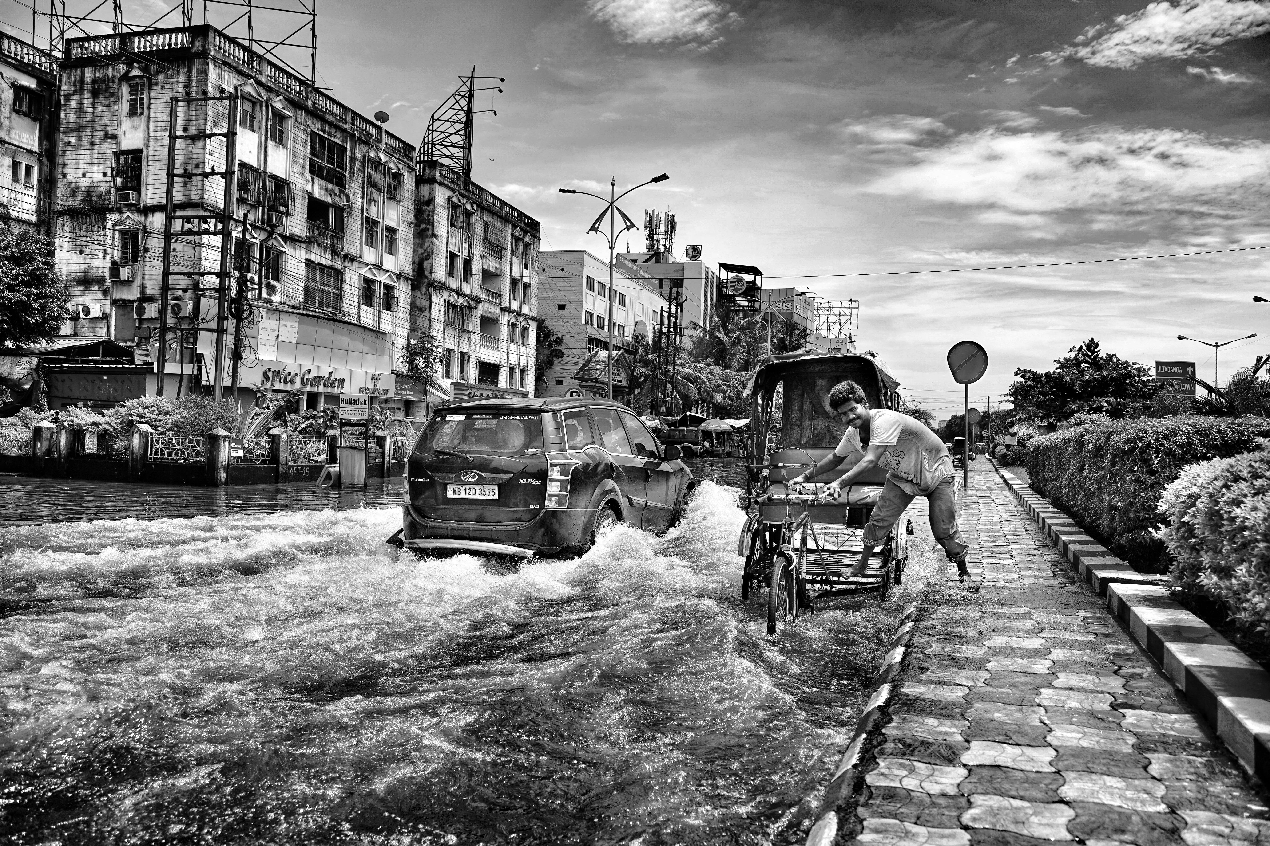 Man with Rickshaw and Car on Street in Water · Free Stock Photo