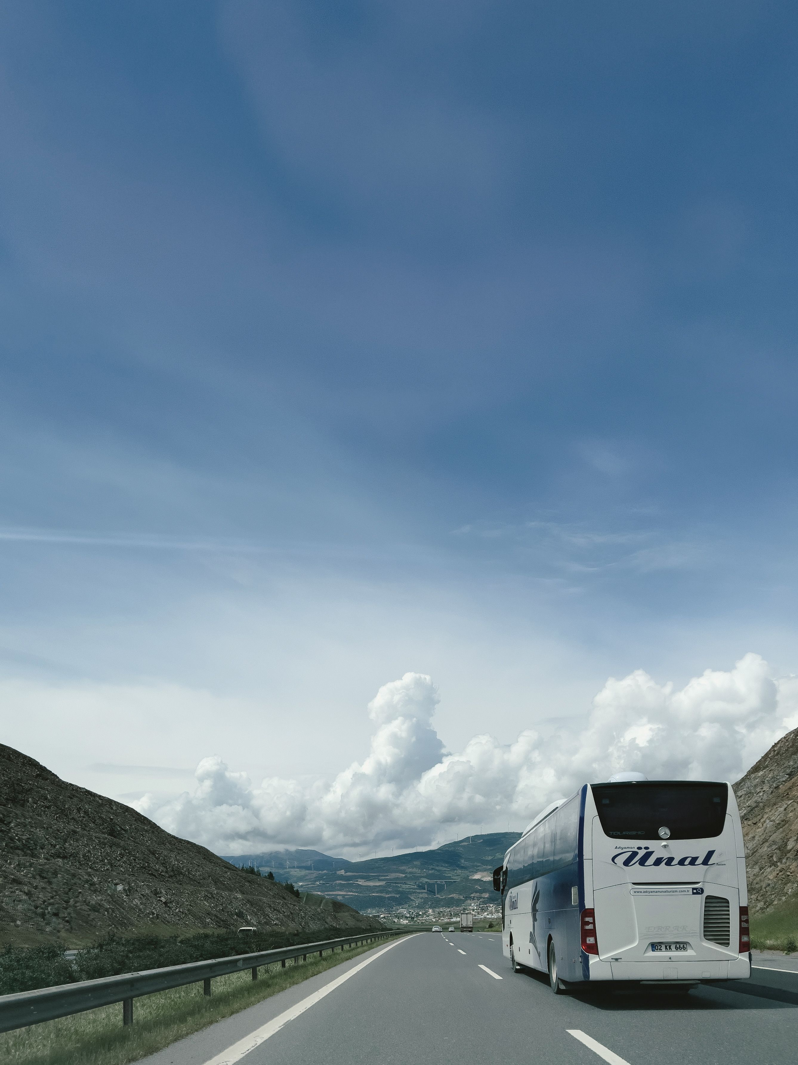 Bus Driving on Highway under Blue Sky · Free Stock Photo
