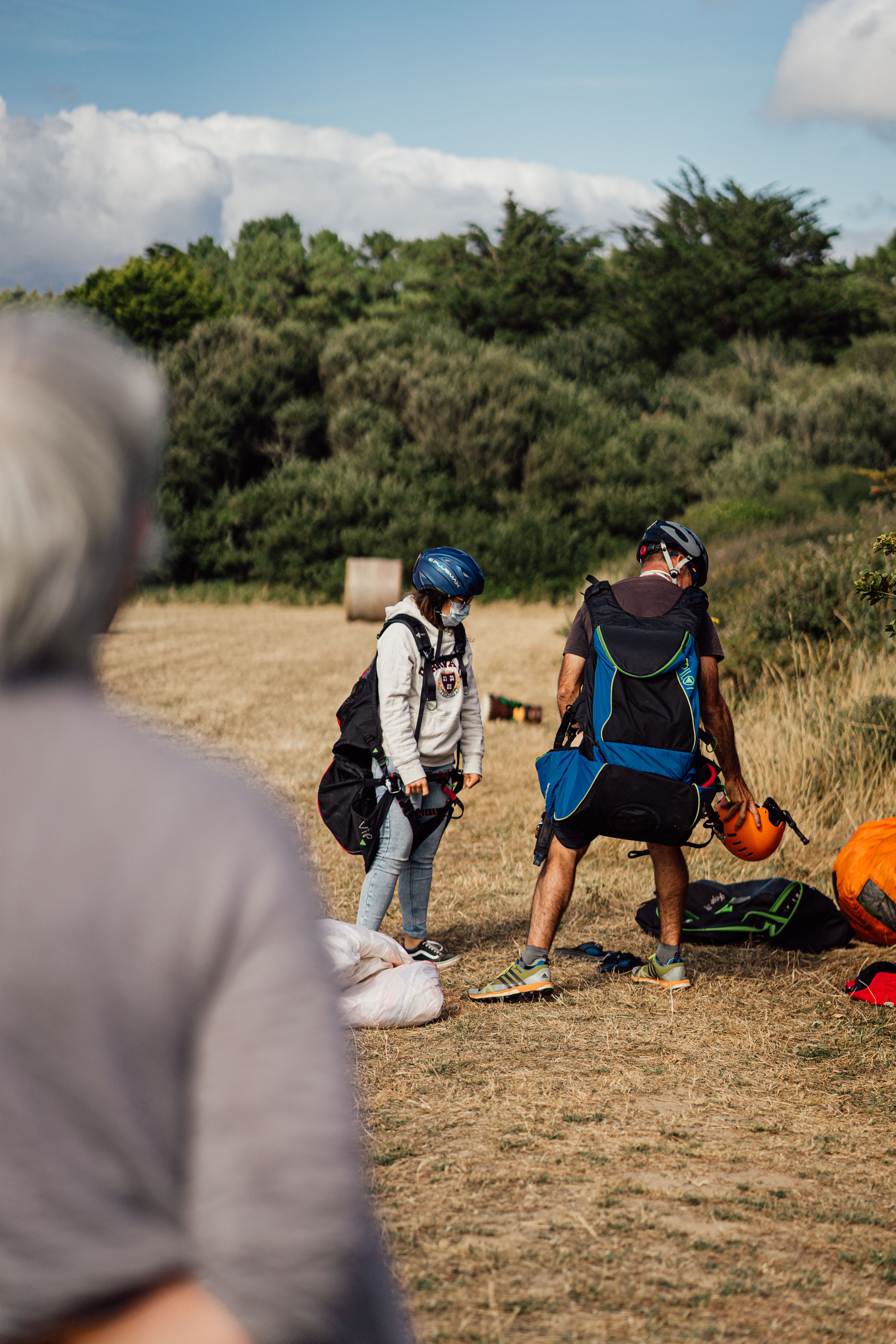 A group of people standing in a field with a parachute · Free Stock Photo