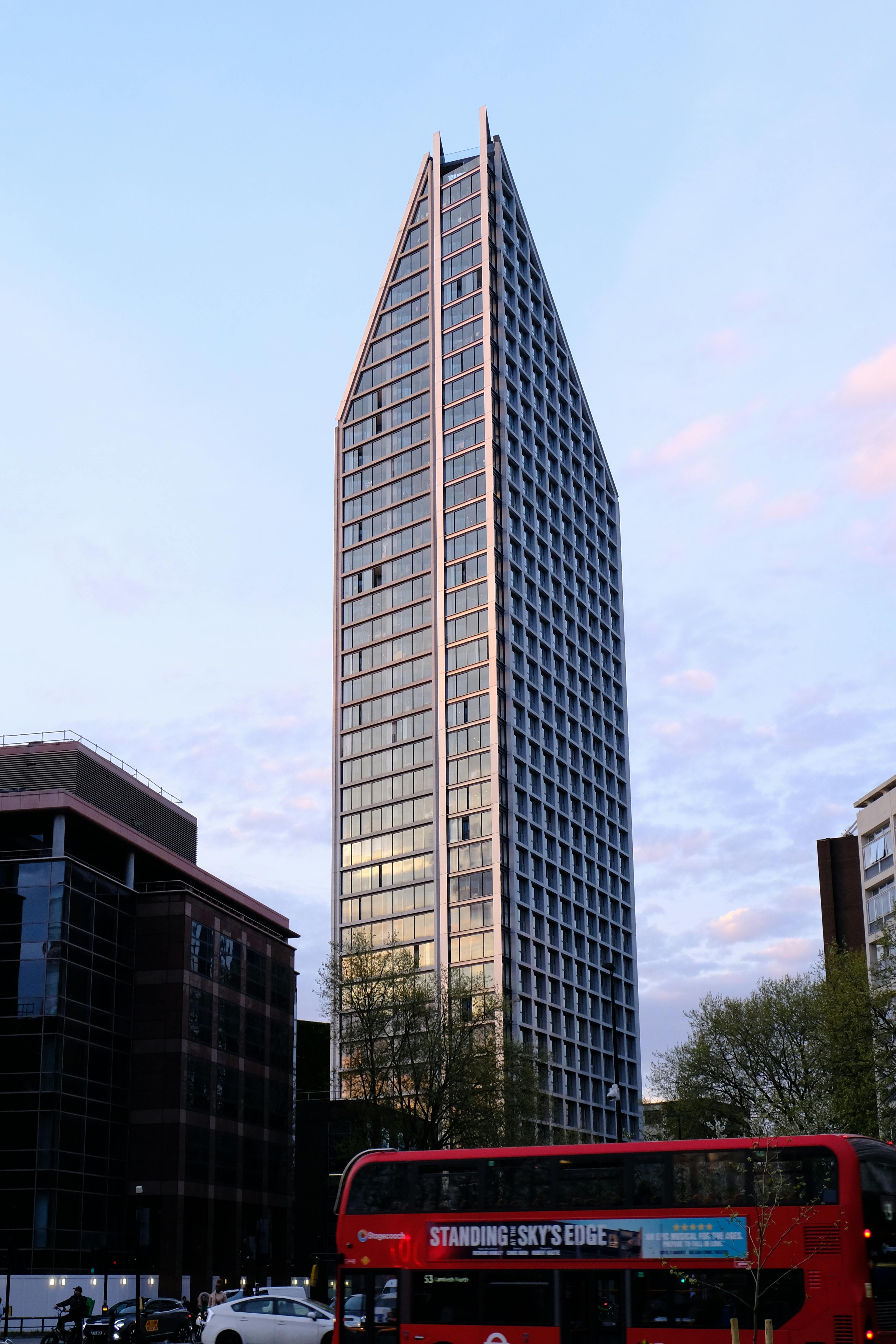 View of a Double-decker Bus and the Two Fifty One Apartment Skyscraper ...