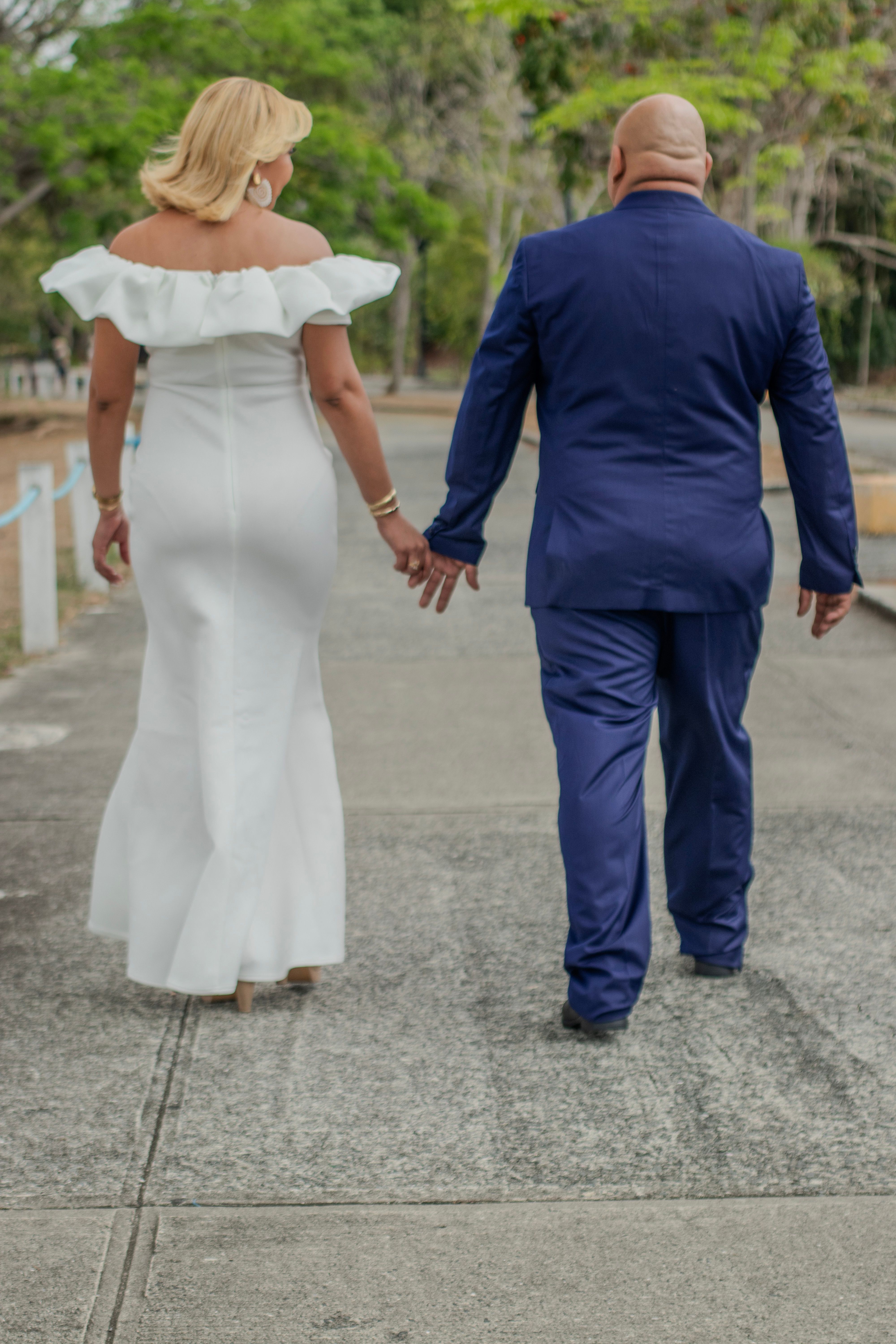 Back View of Newlyweds Holding Hands and Walking Together · Free Stock ...