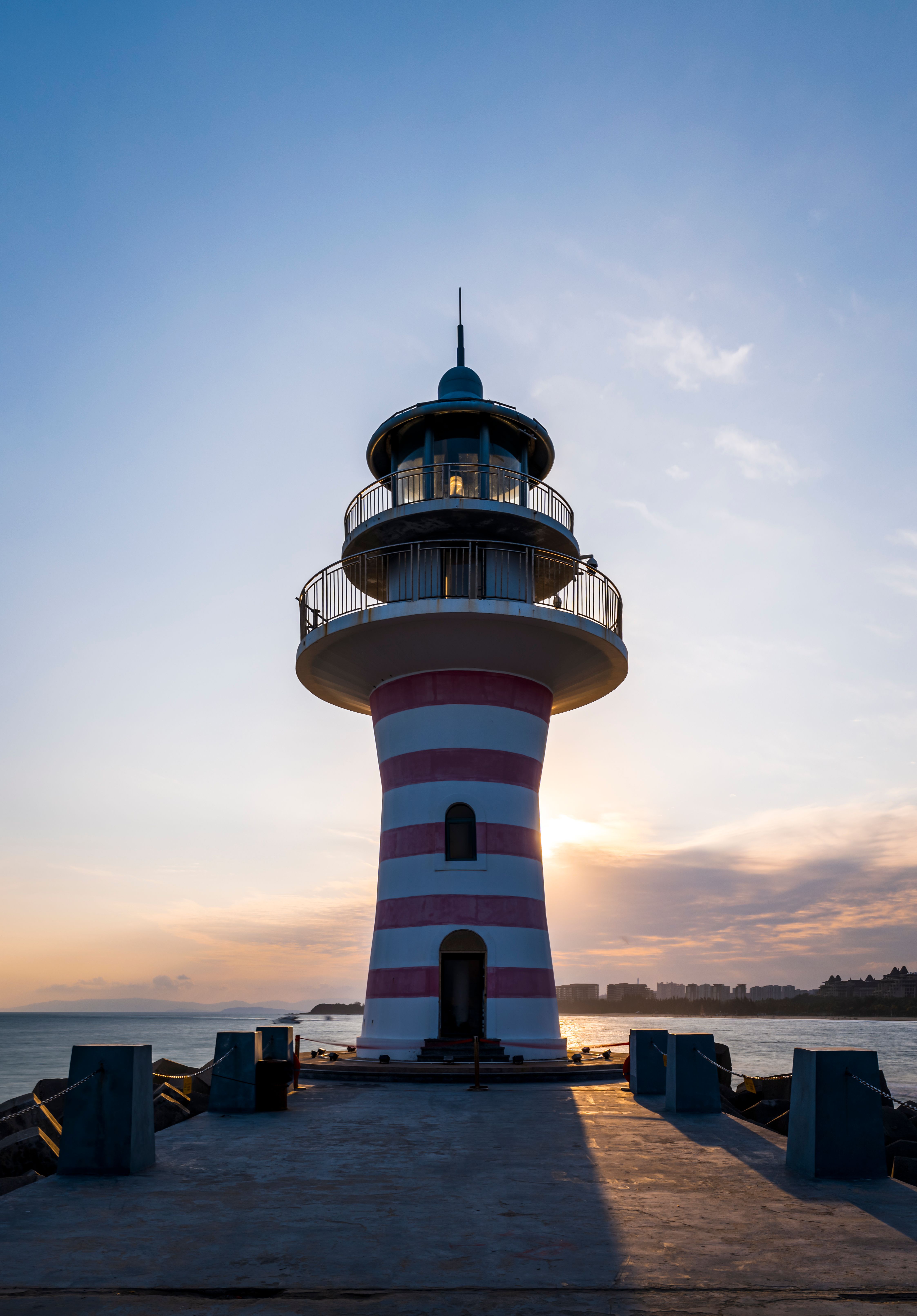 Striped Lighthouse at Sunset · Free Stock Photo