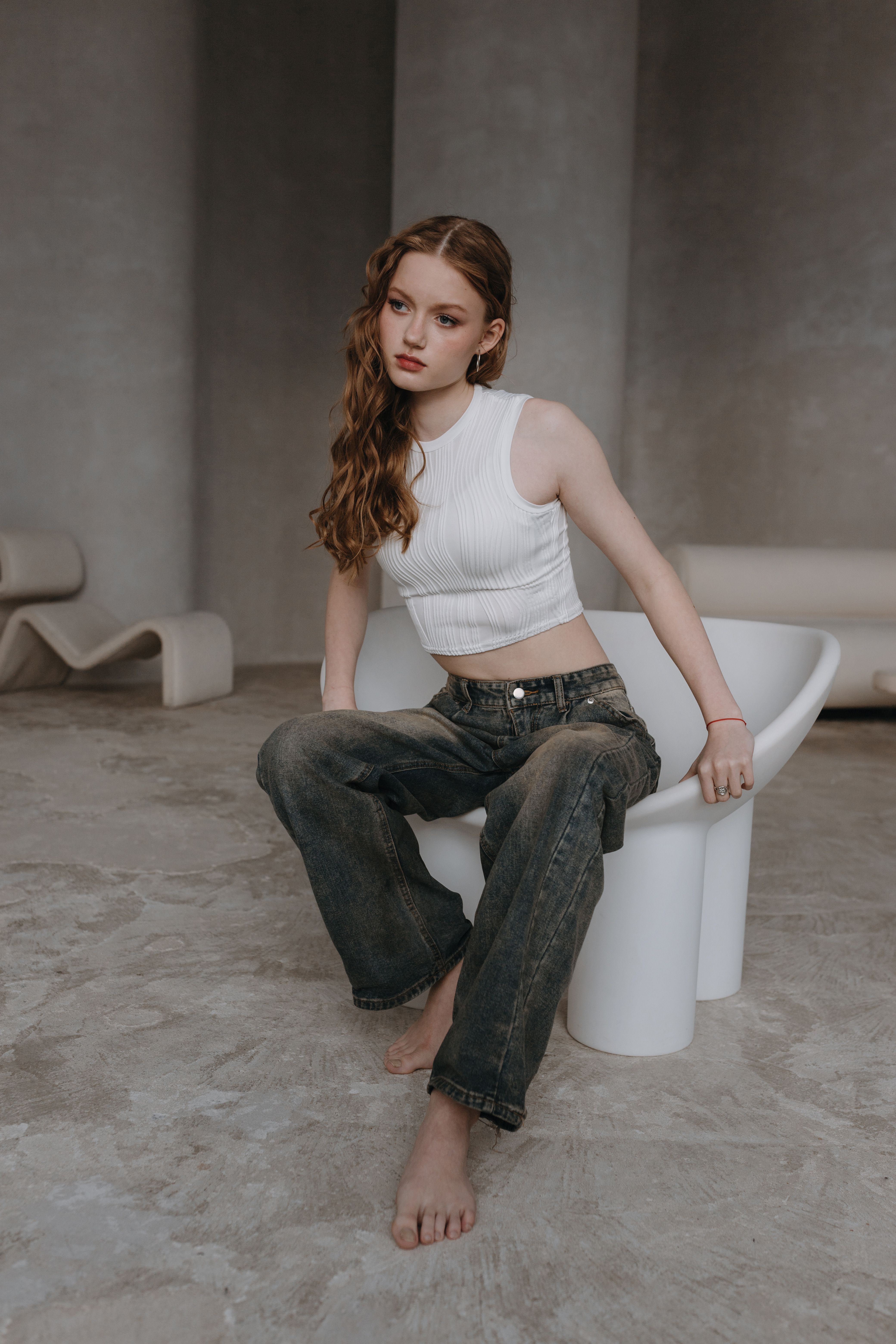 Barefoot Woman in Jeans Sitting on Chair · Free Stock Photo