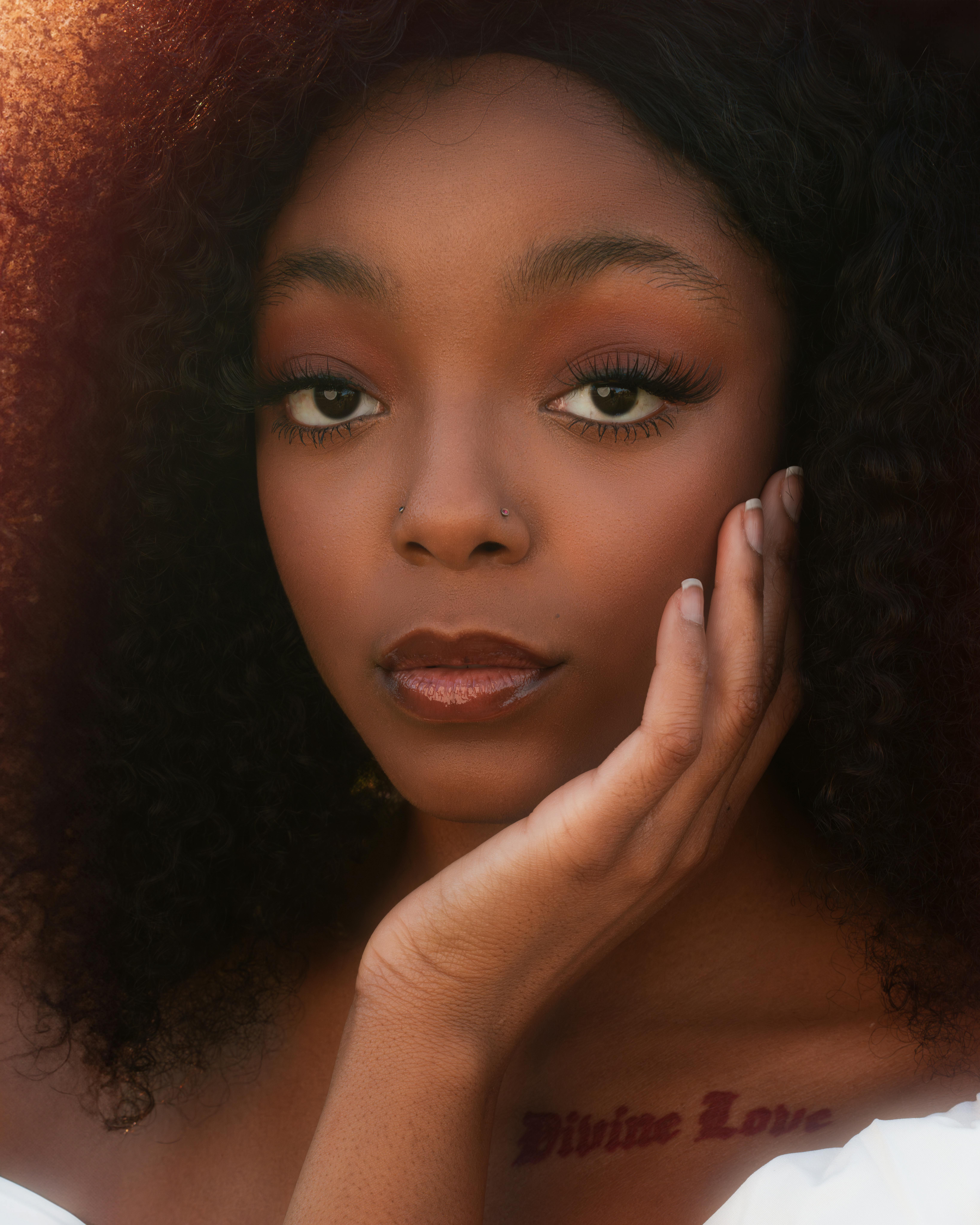 Woman with Hand on Cheek · Free Stock Photo