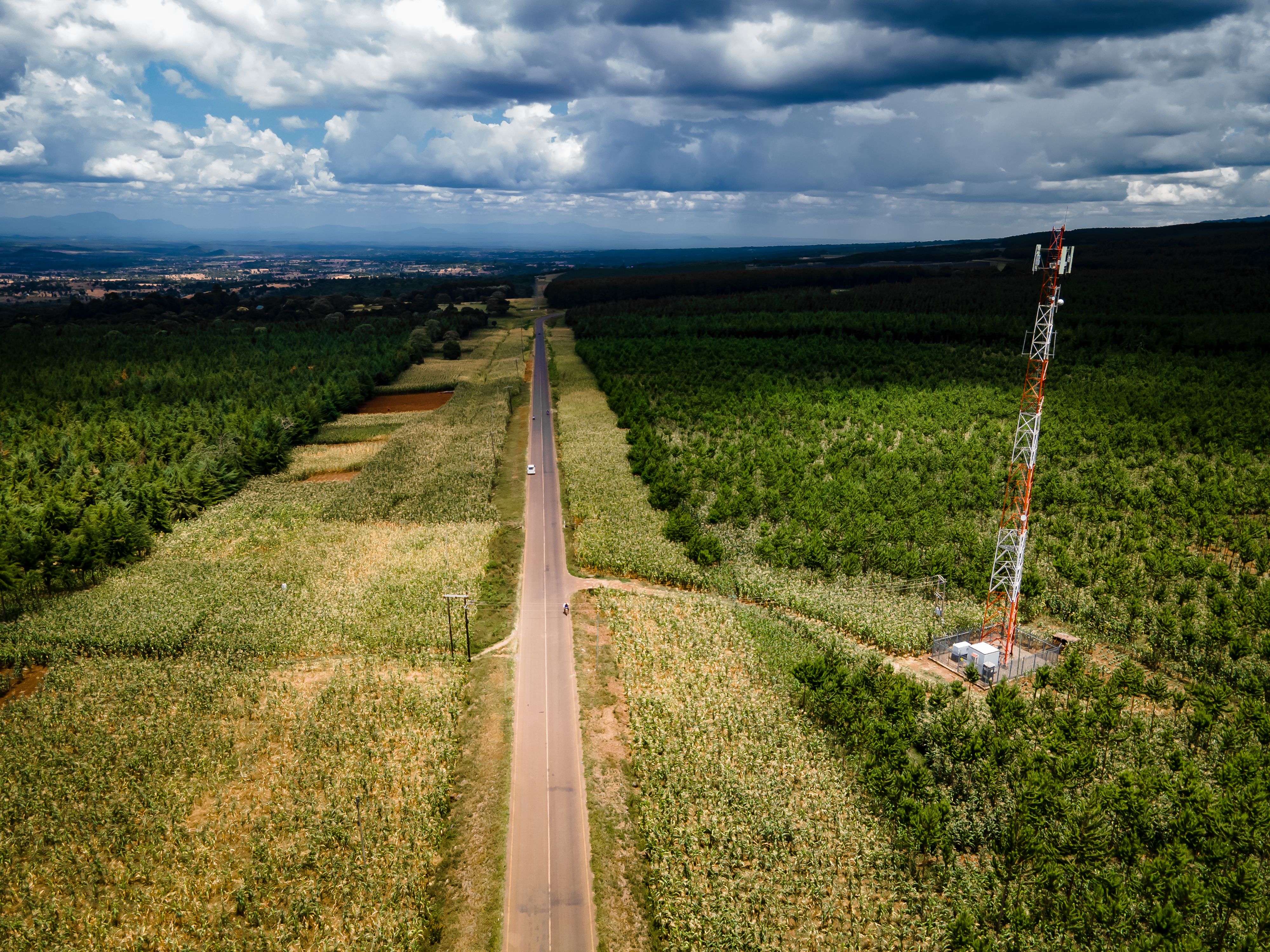 An aerial view of a road and a cell tower · Free Stock Photo