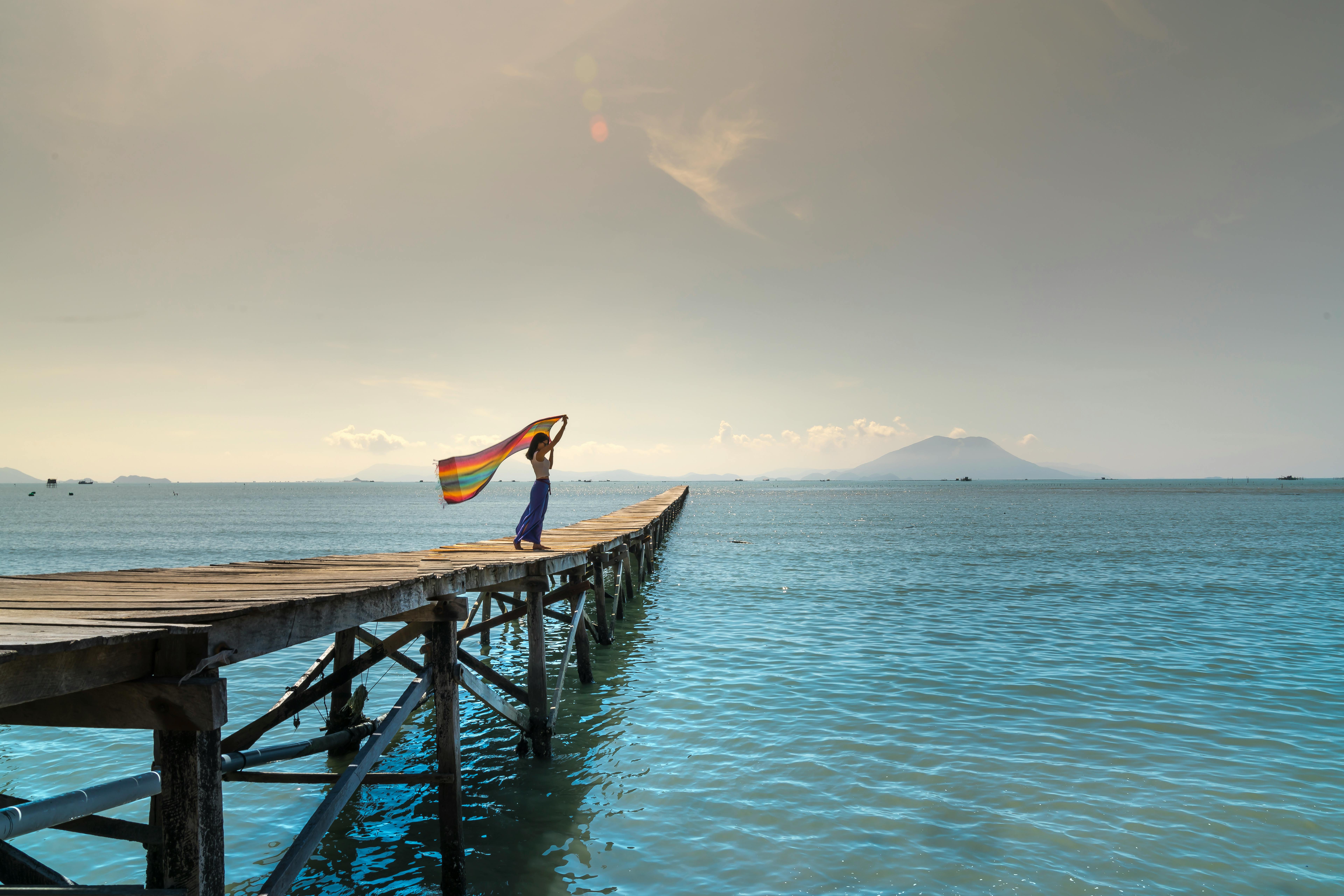 People Sitting on Brown Wooden Dock · Free Stock Photo