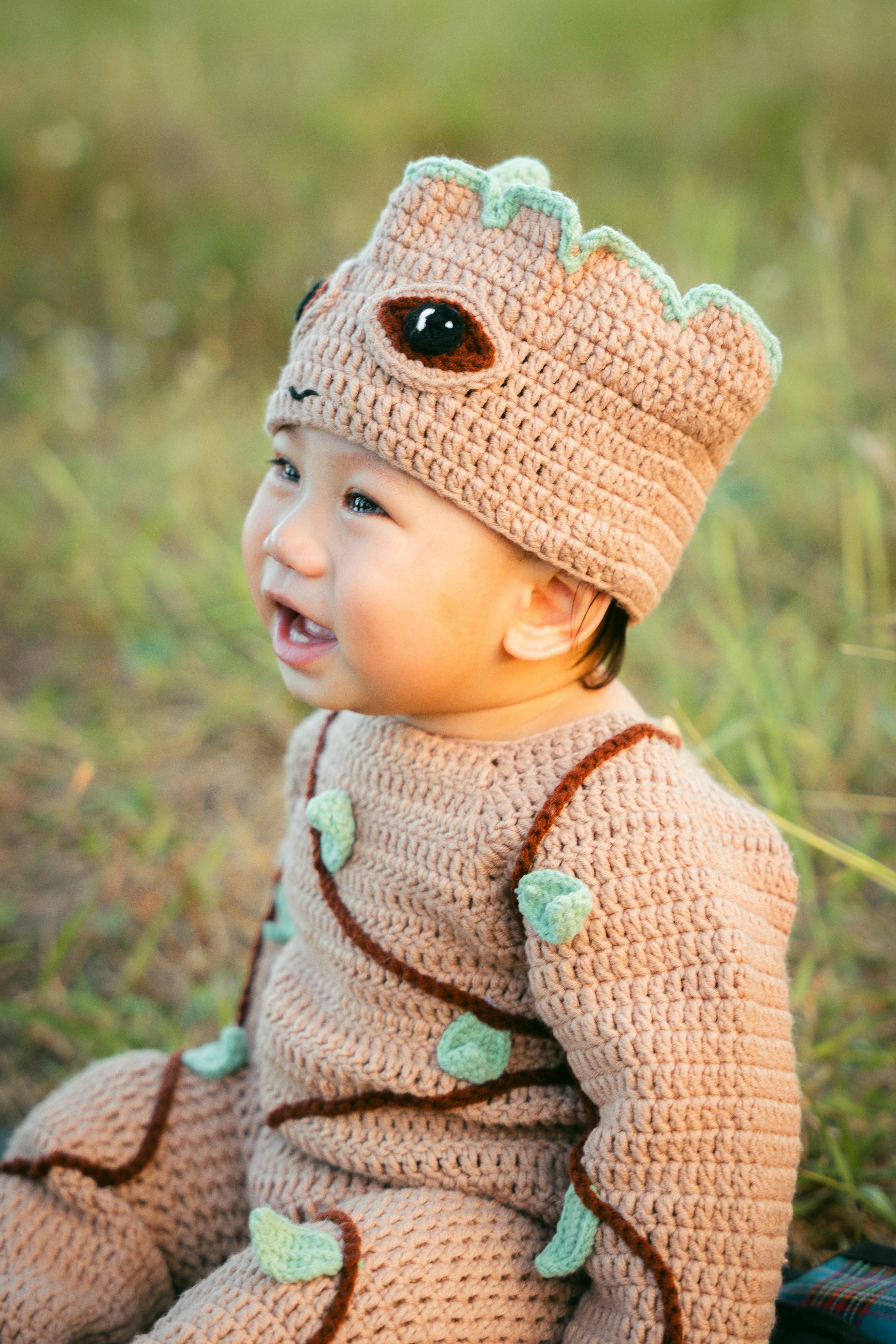 Little Baby Wearing Woolen Costume on a Meadow · Free Stock Photo