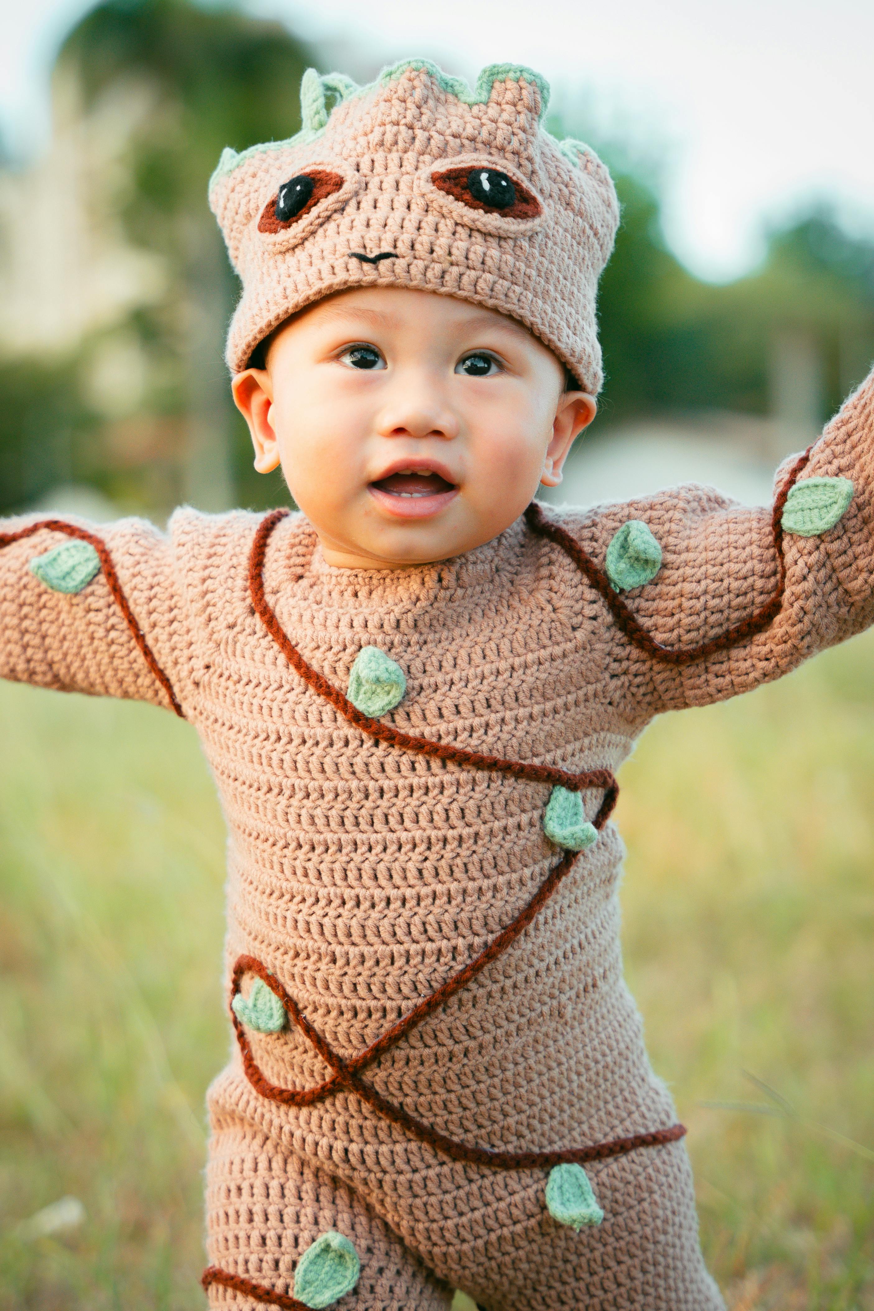 Little Baby Wearing Woolen Costume on a Meadow · Free Stock Photo