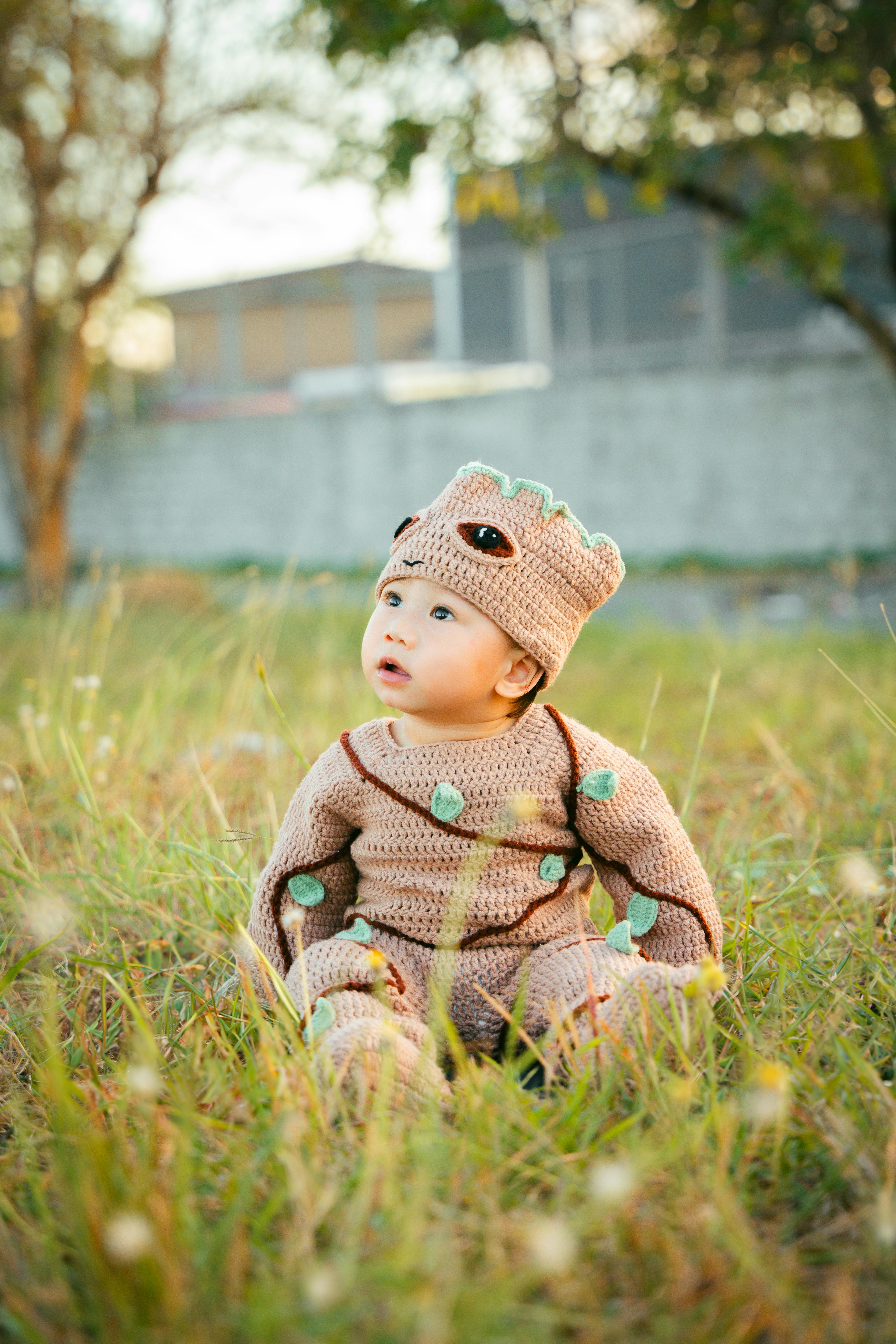 Little Baby Wearing Woolen Costume on a Meadow · Free Stock Photo