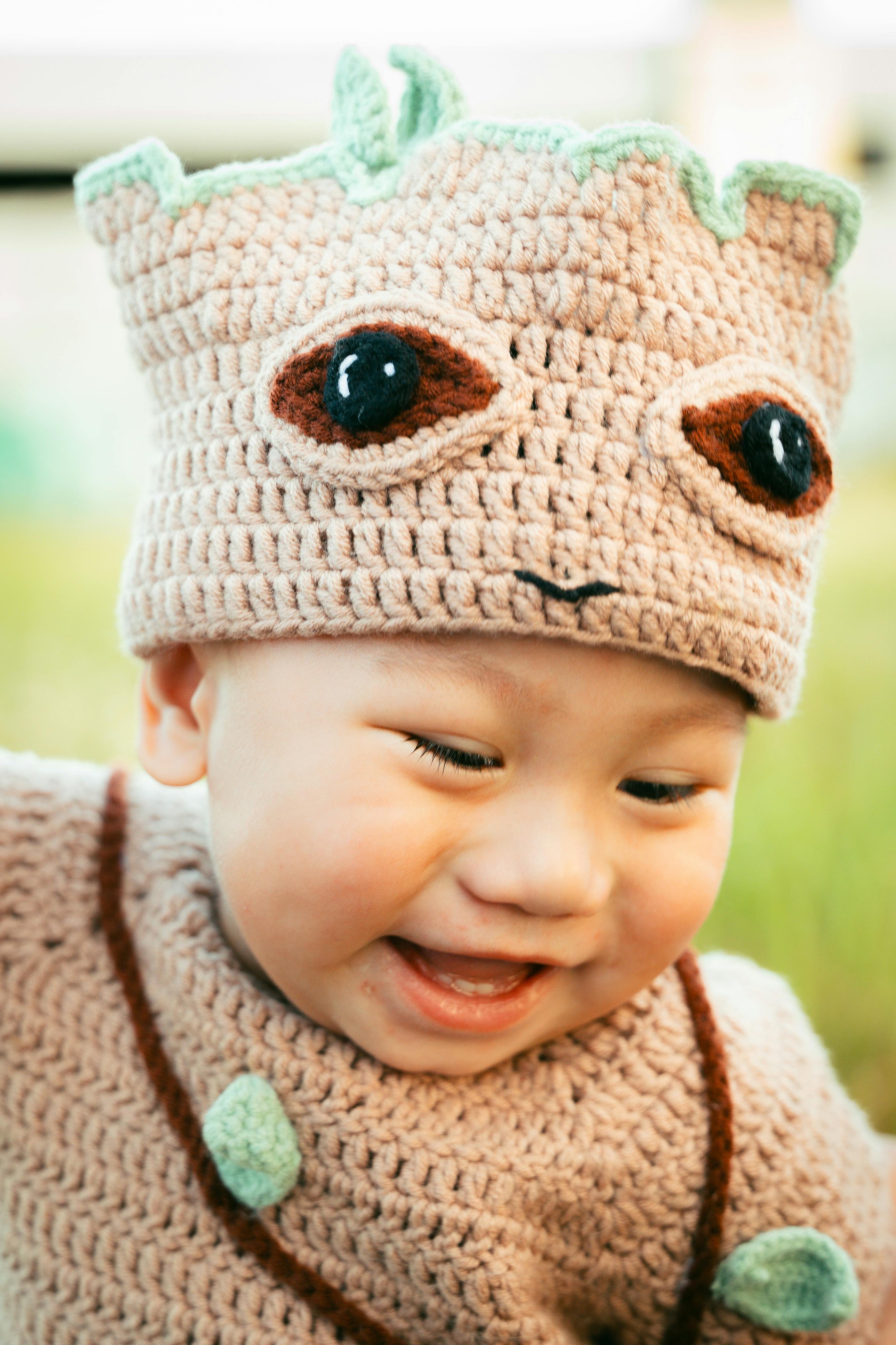 Little Baby Wearing Woolen Costume on a Meadow · Free Stock Photo